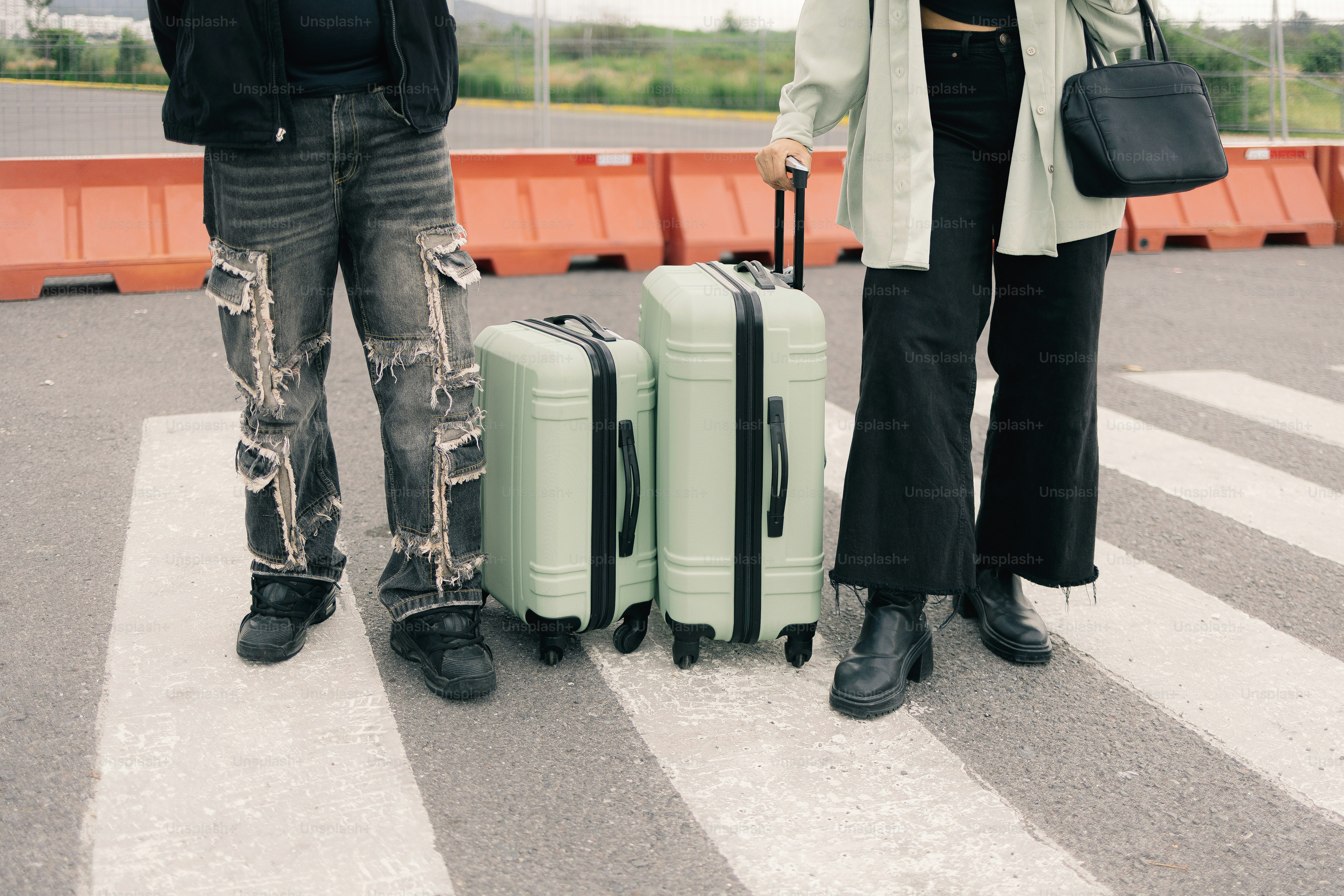 Two people with luggage on a crosswalk photo – Adventure Image on Unsplash