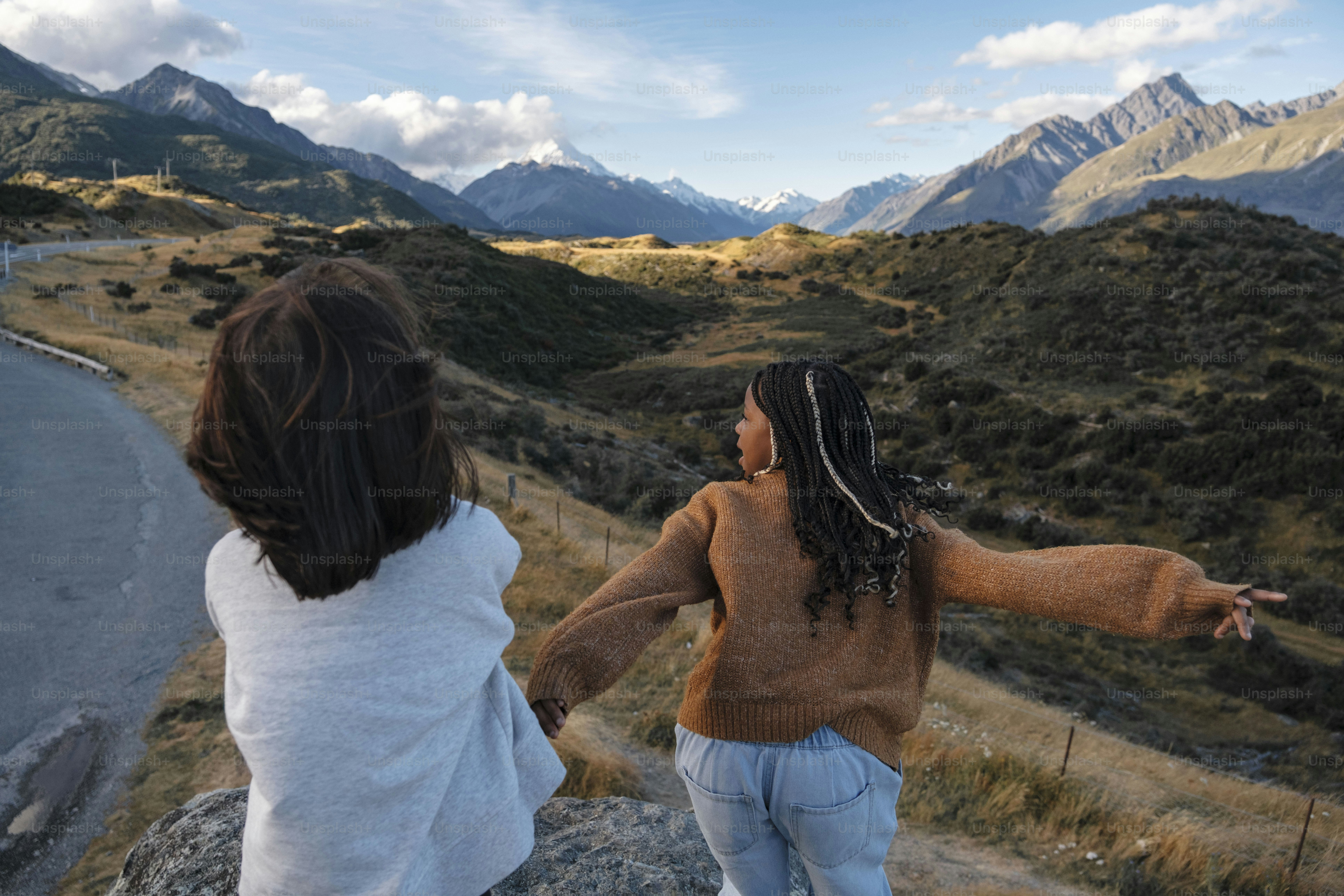 Two girls climbing a large rock outdoors photo – Travel Image on Unsplash