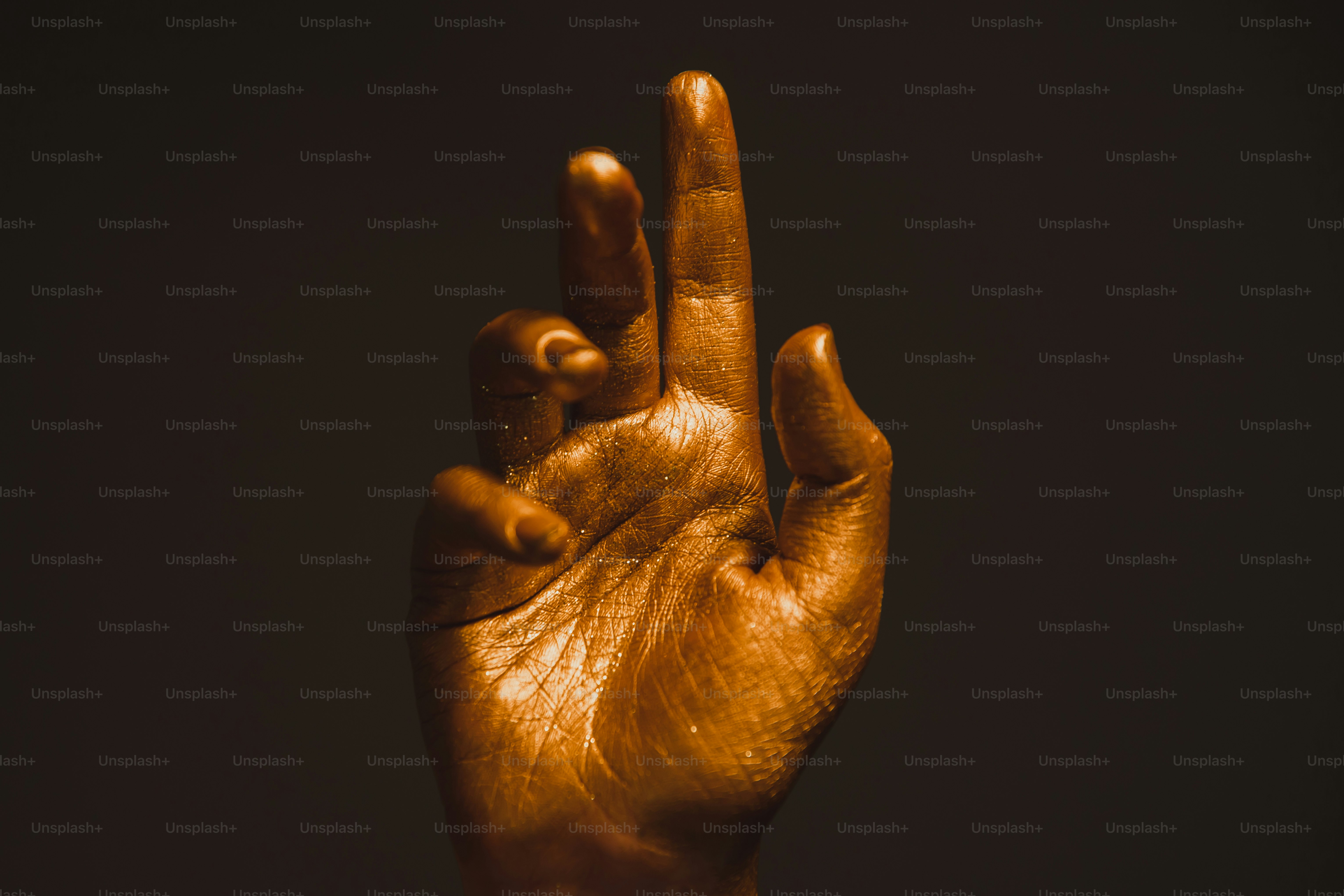 A hand covered in gold paint reaches upwards. photo – Texture Image on ...