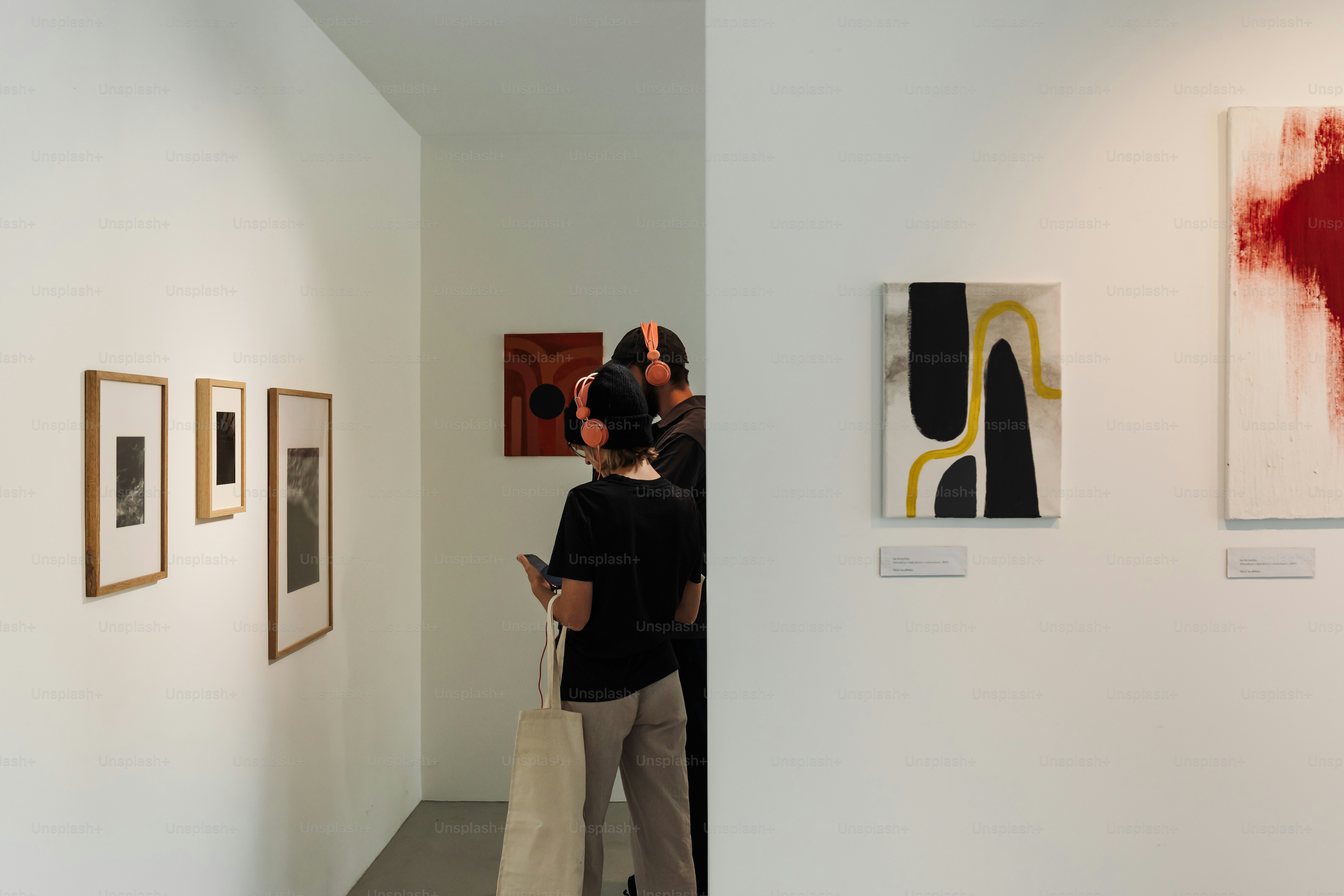 People looking at art in a modern gallery. photo – Art gallery Image on ...