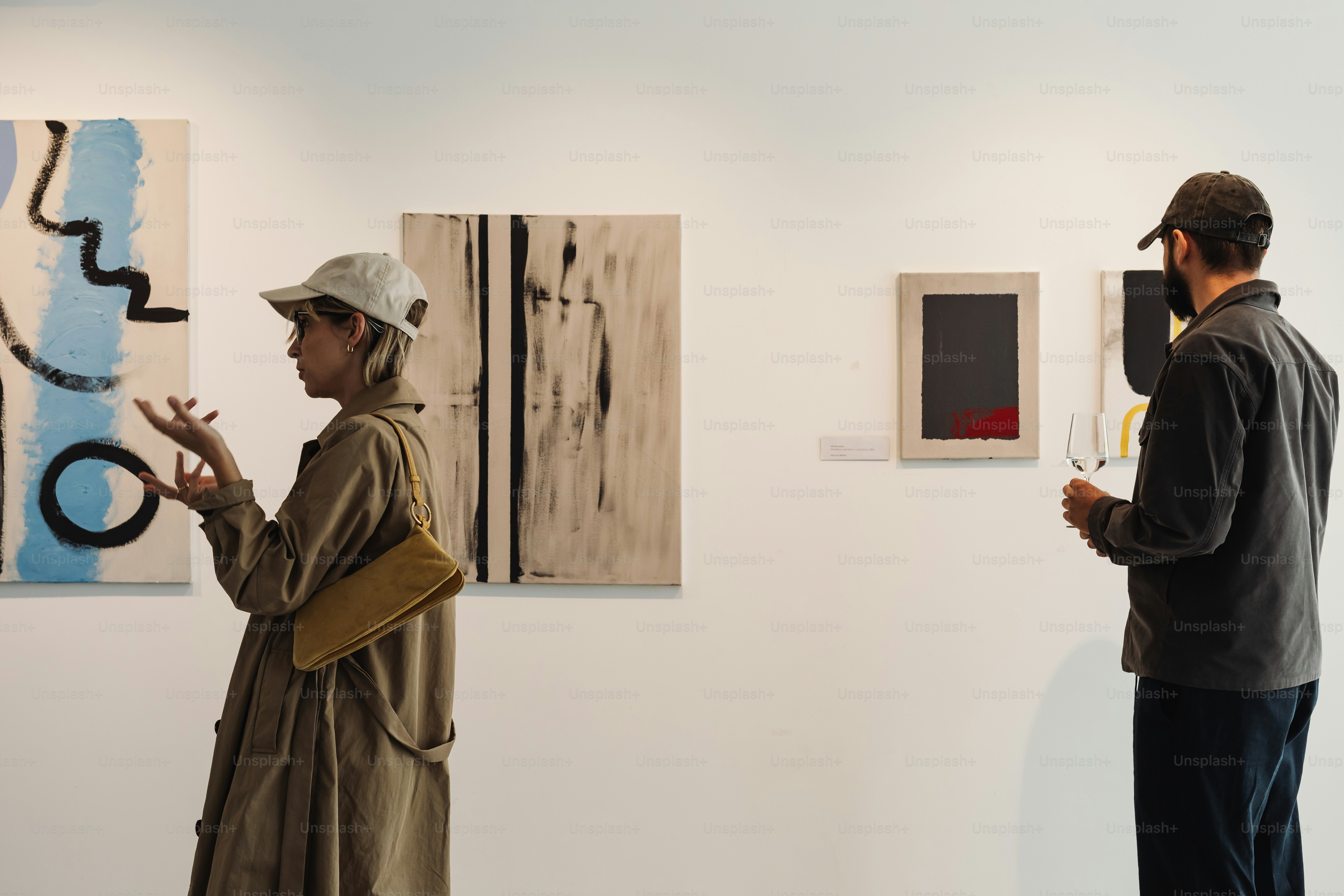 People looking at art in a modern gallery. photo – Art gallery Image on ...