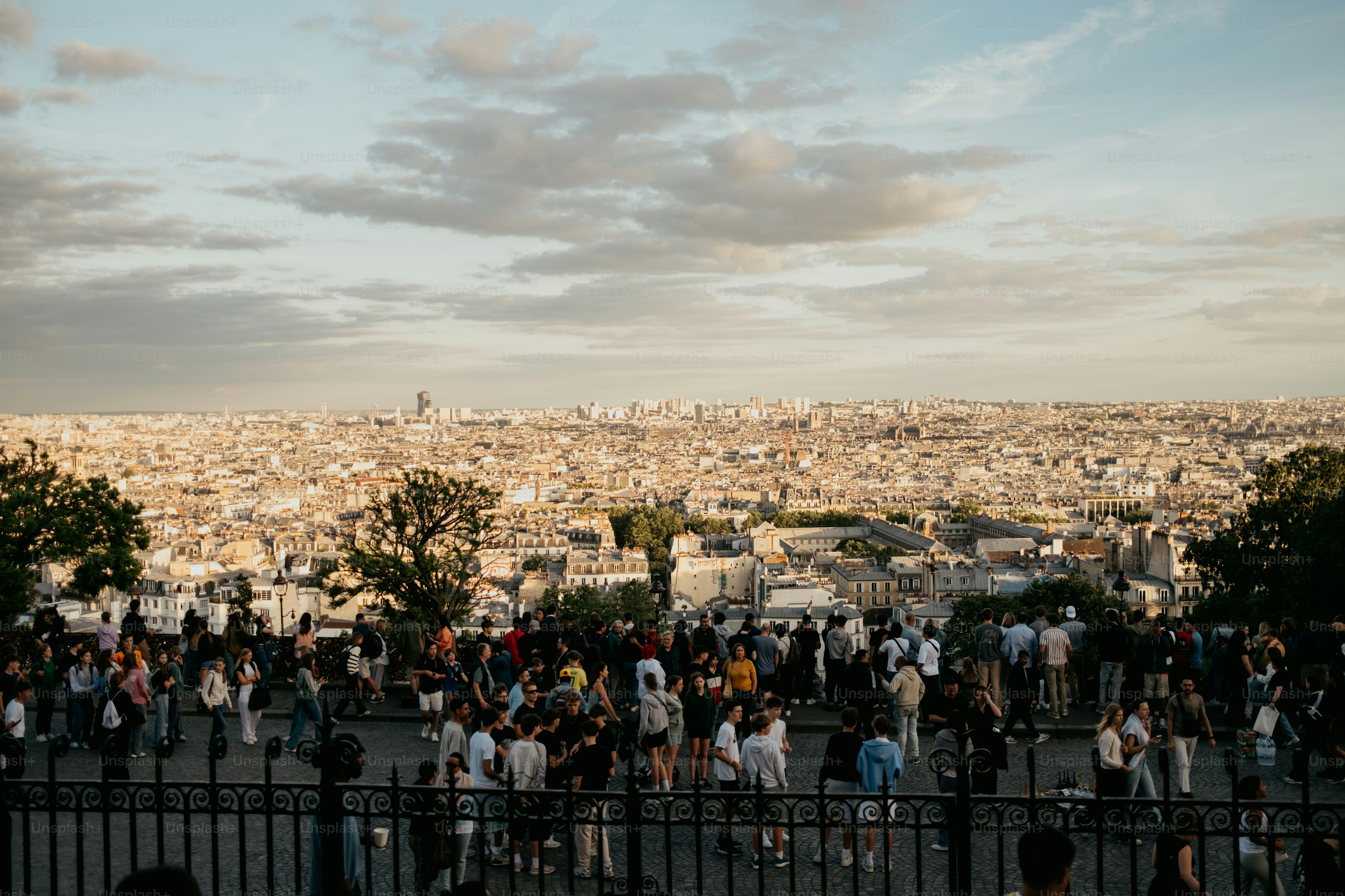 Crowd of people overlooking a sprawling city skyline. photo – Crowd ...