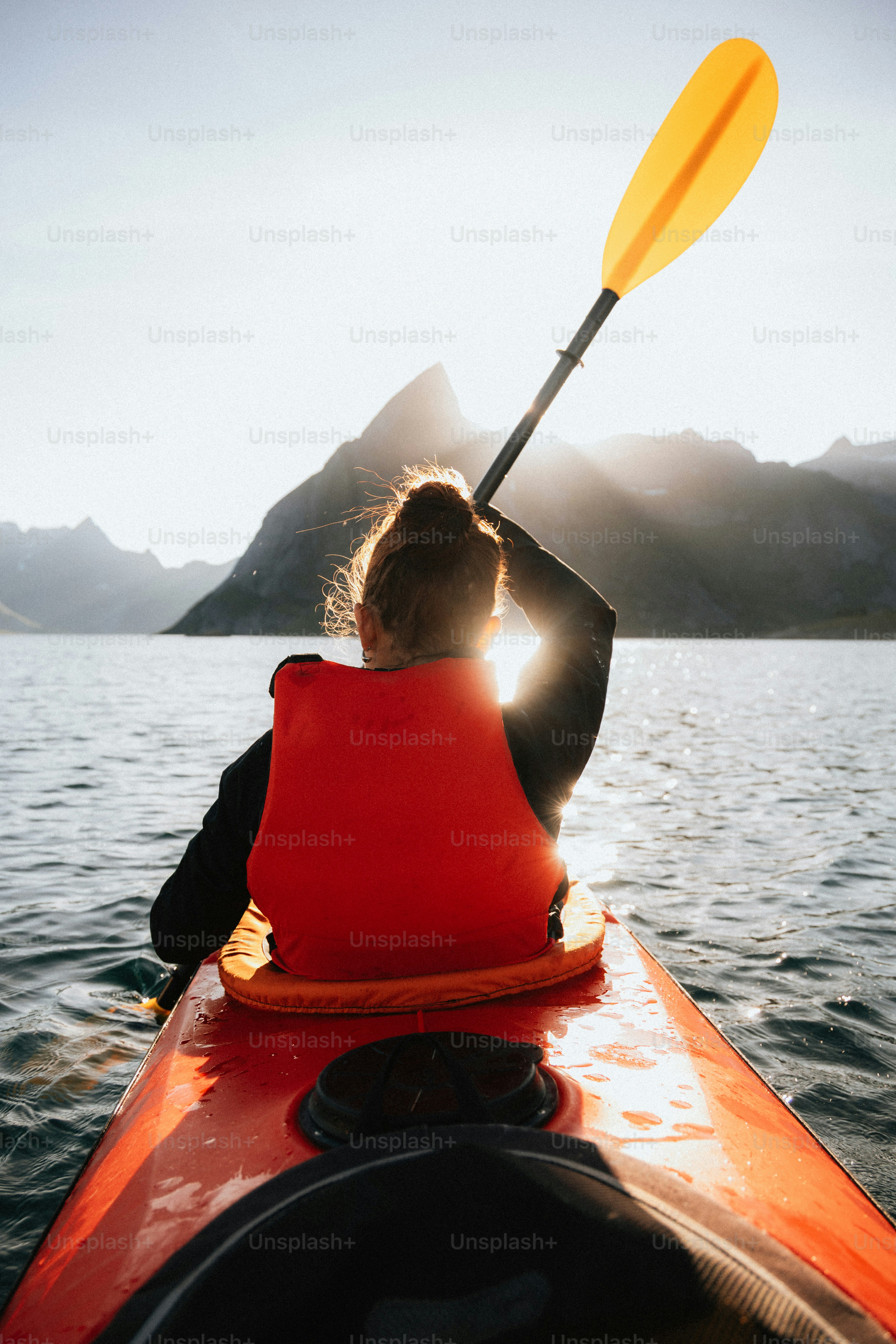 Two surfers paddling on a calm ocean at sunset photo – Travel Image on ...