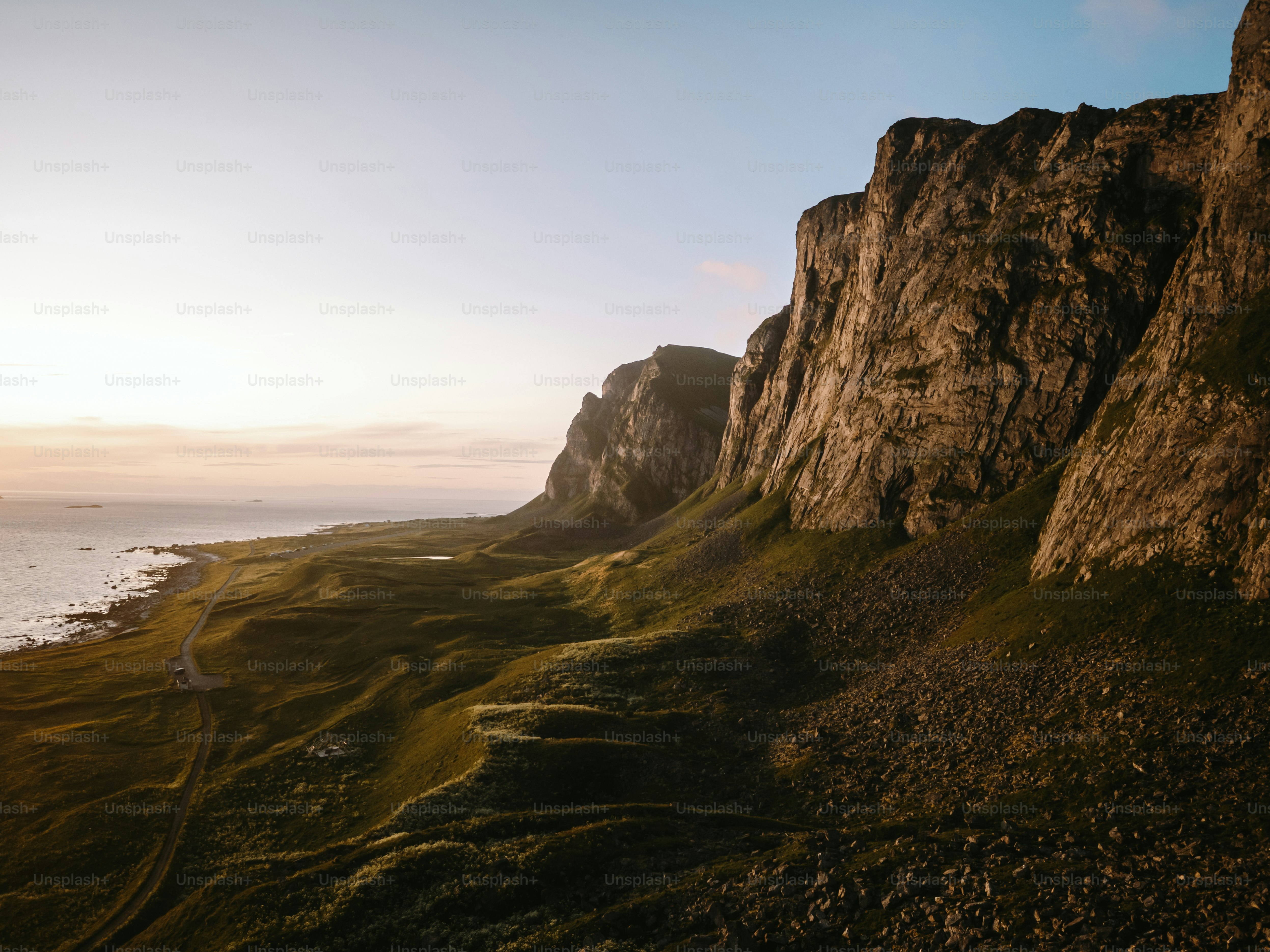 Dramatic coastal cliffs bathed in warm sunset light. photo – Travel ...