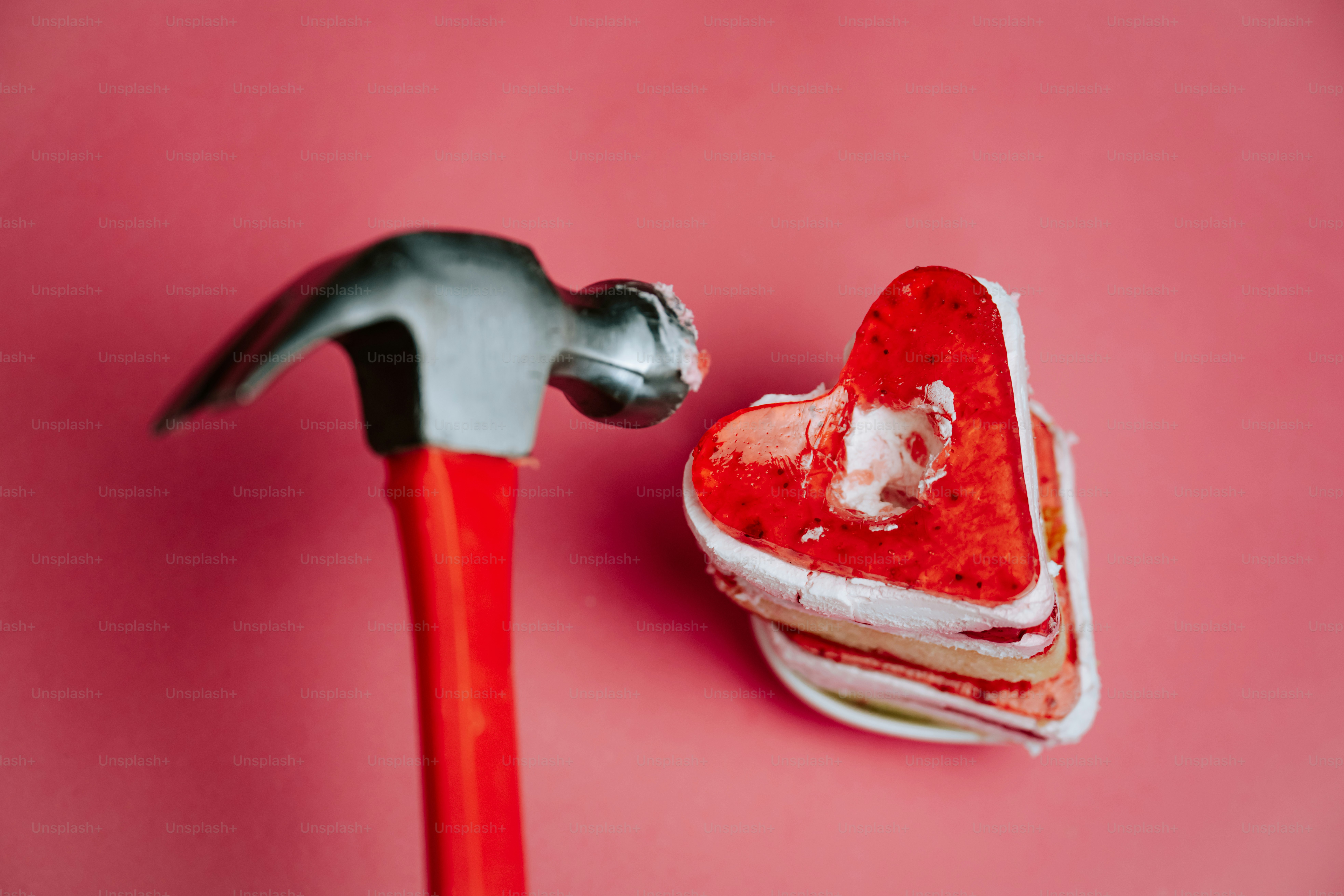 Hammer about to strike a broken heart cake. photo – Relationship Image ...