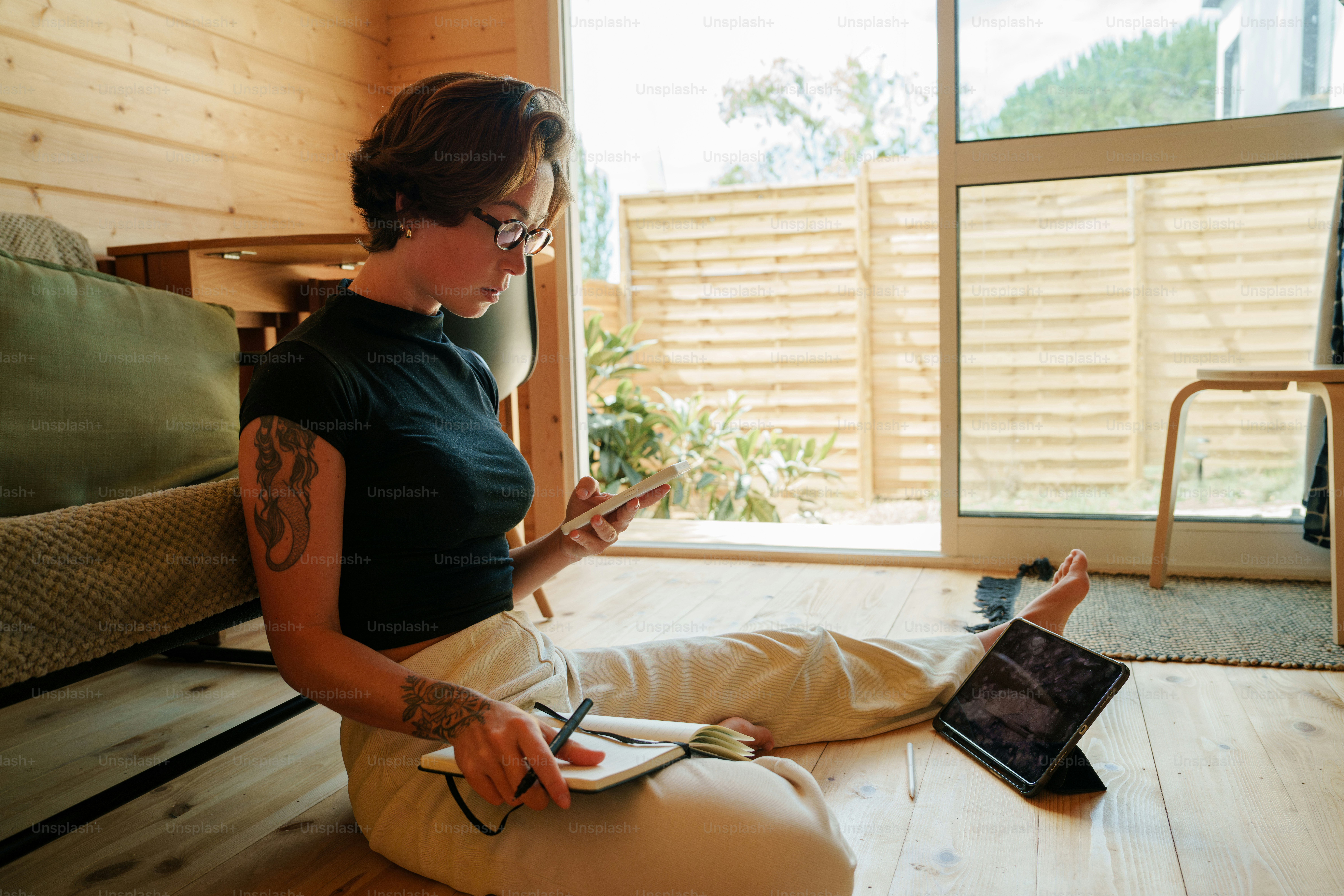 Woman using phone and tablet on floor photo – Woman Image on Unsplash