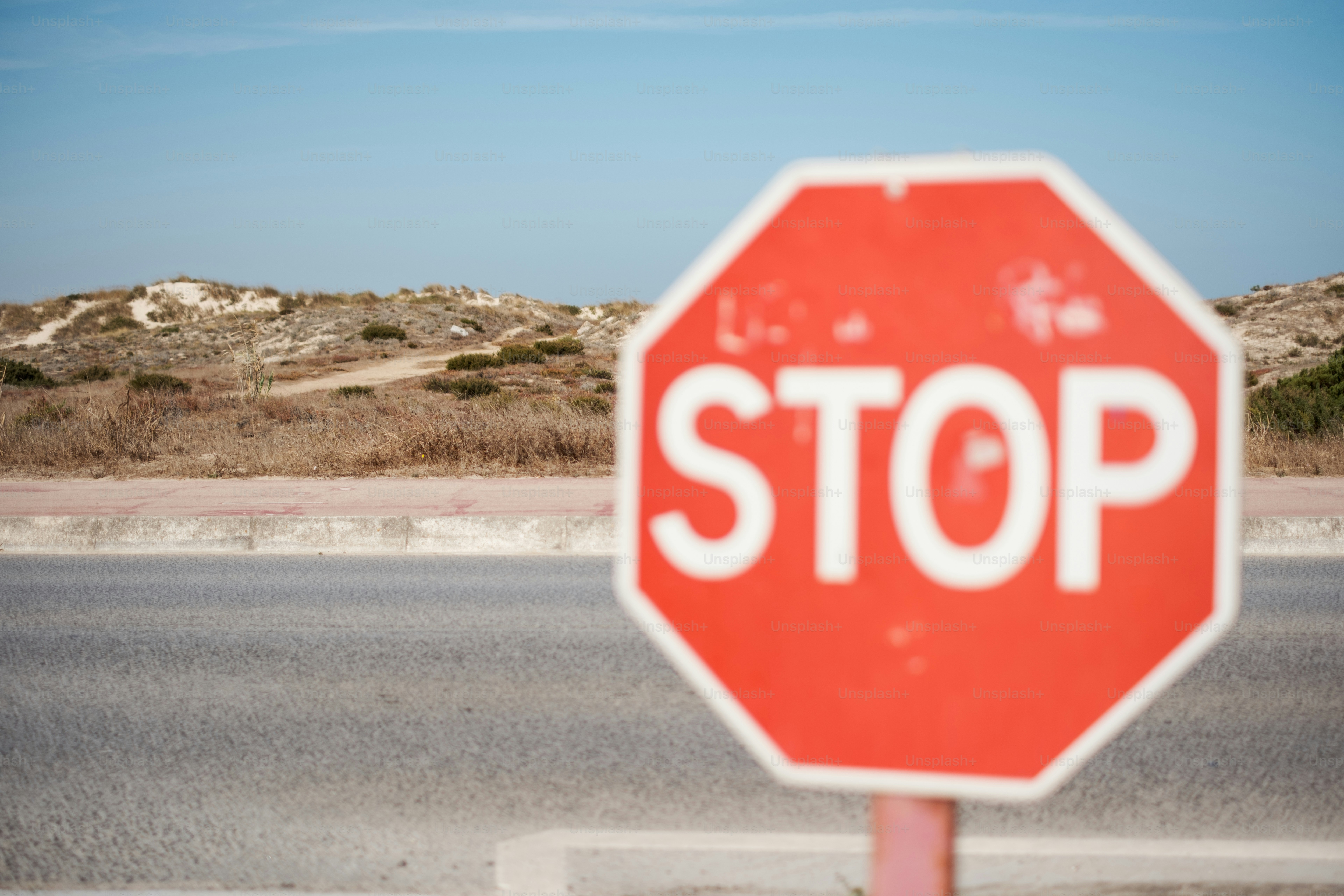 Red stop sign on a road photo – Blur Image on Unsplash