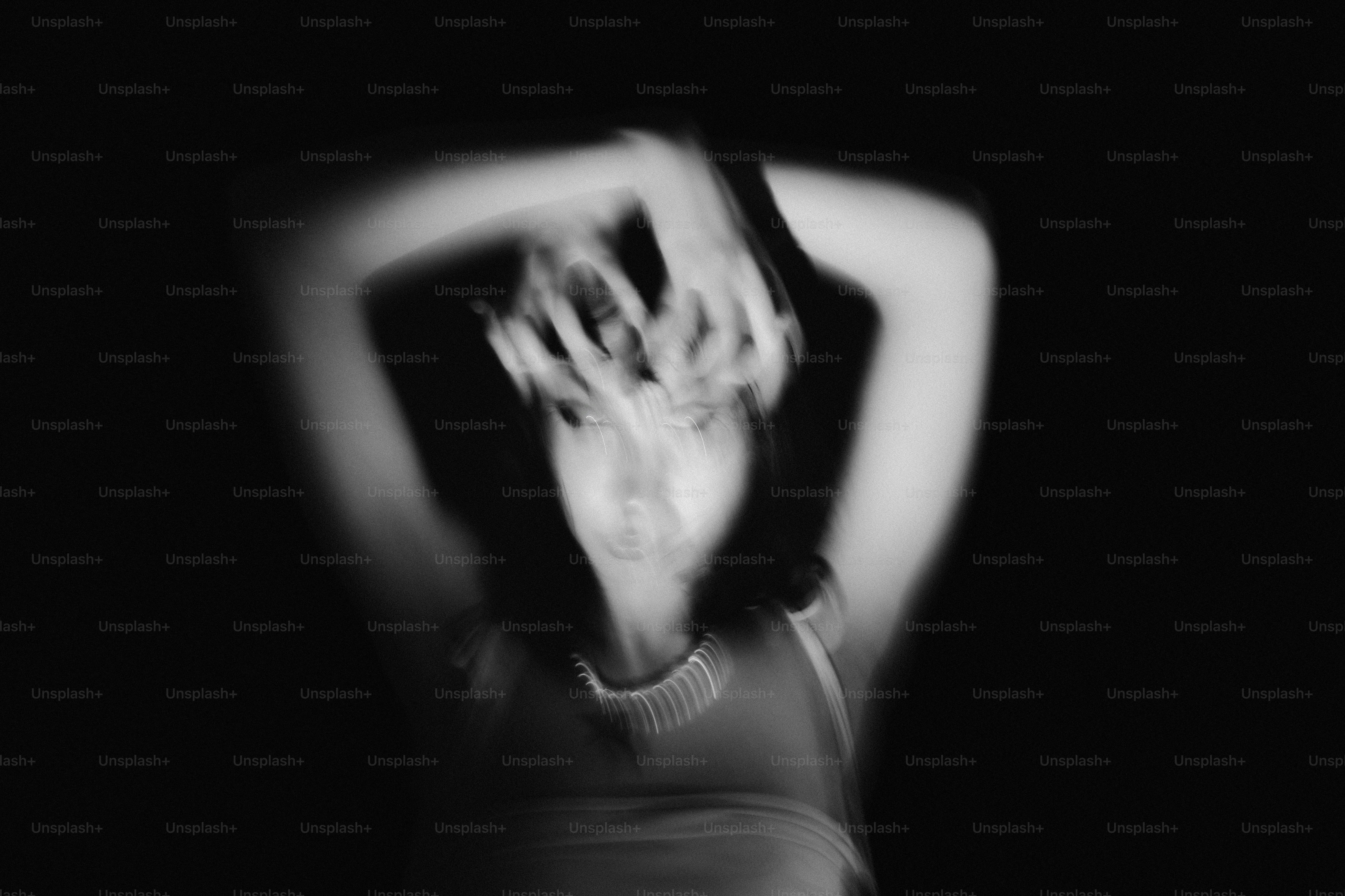 Blurred figure with arms raised behind head photo – Dark Image on Unsplash