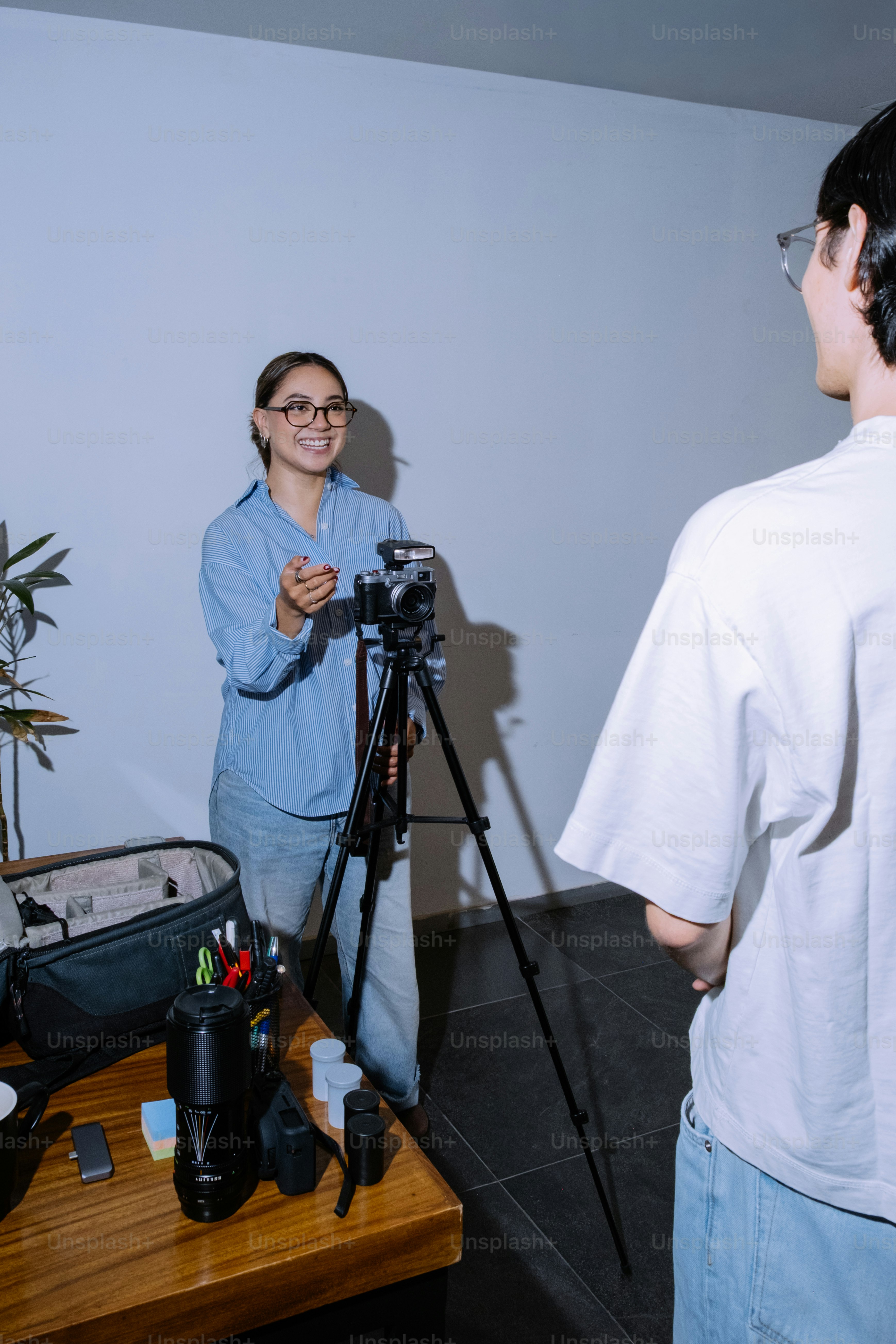 Person packing camera gear into a bag. photo – Professional Image on ...