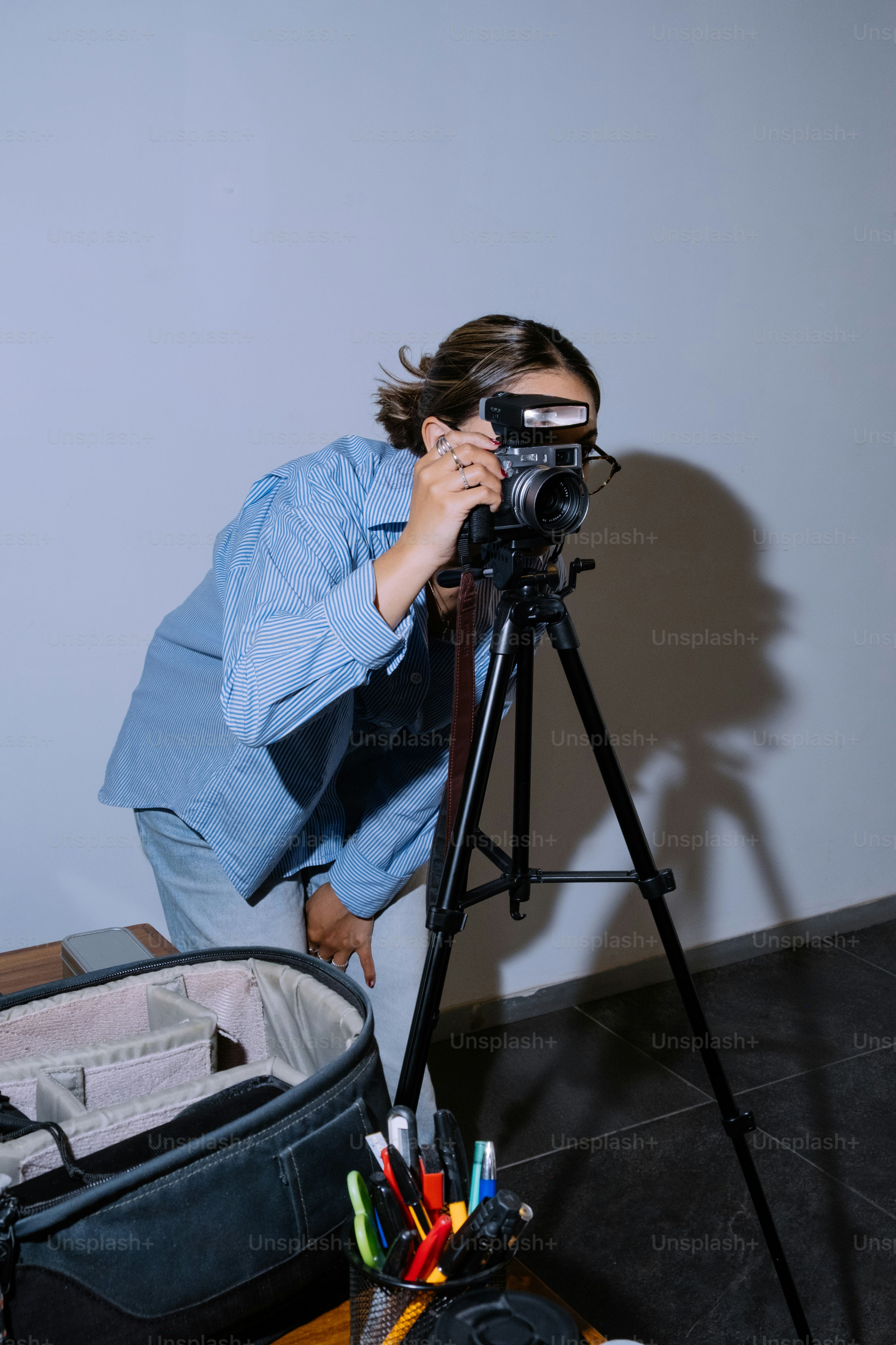 Person packing camera gear into a bag. photo – Professional Image on ...