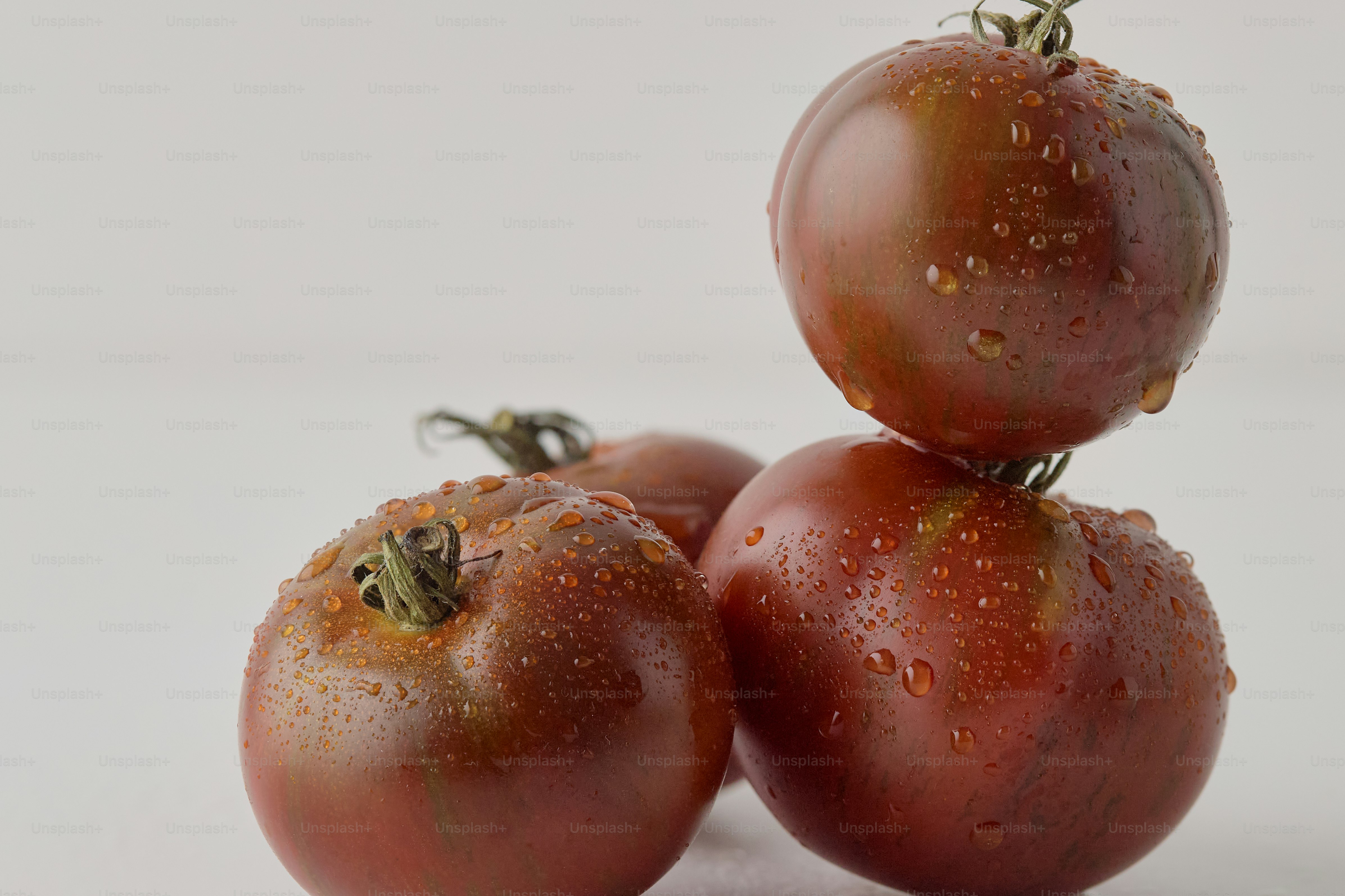 Three dark red tomatoes with water droplets. photo – Food Image on Unsplash