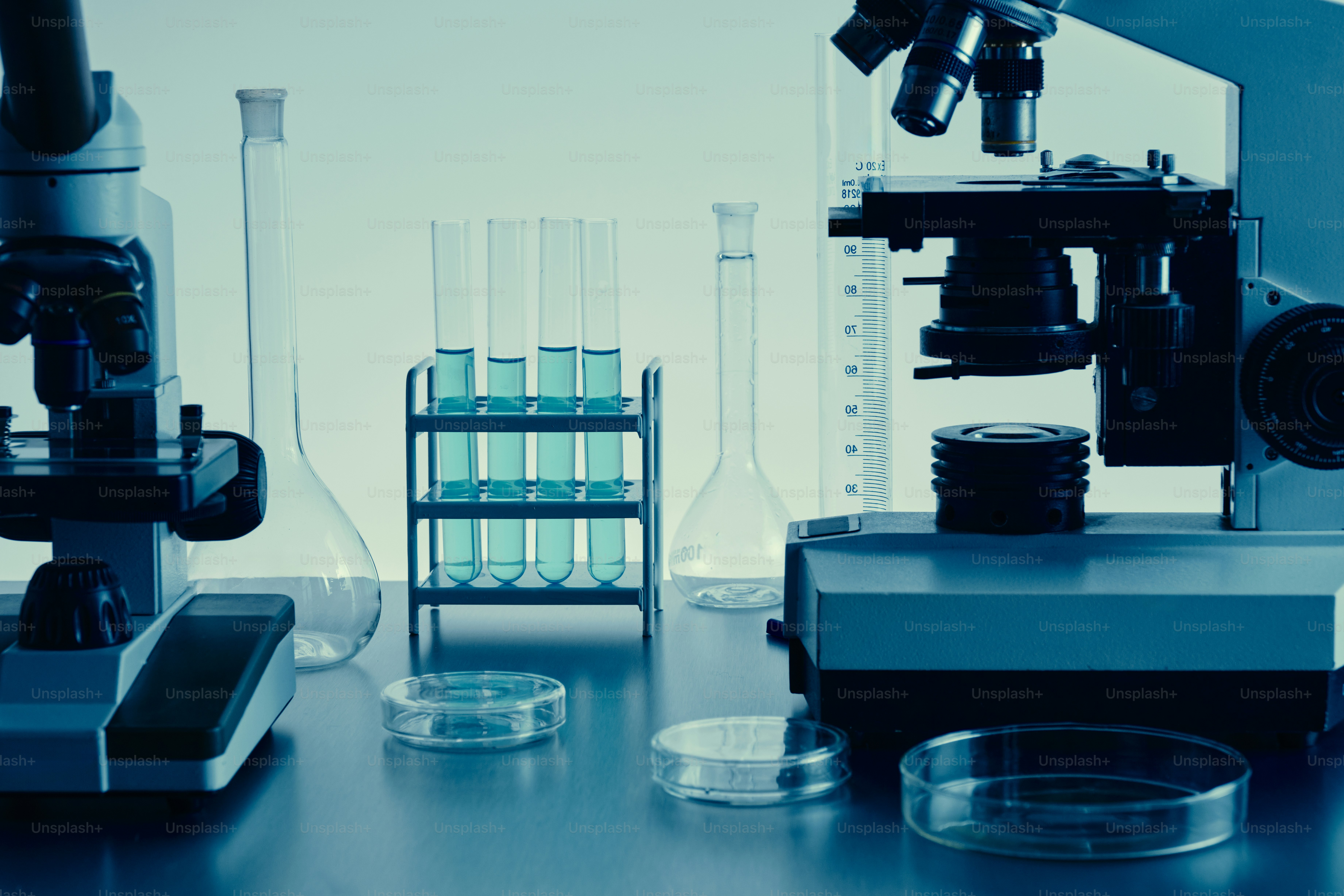 Microscopes and test tubes in a laboratory setting. photo – Science ...