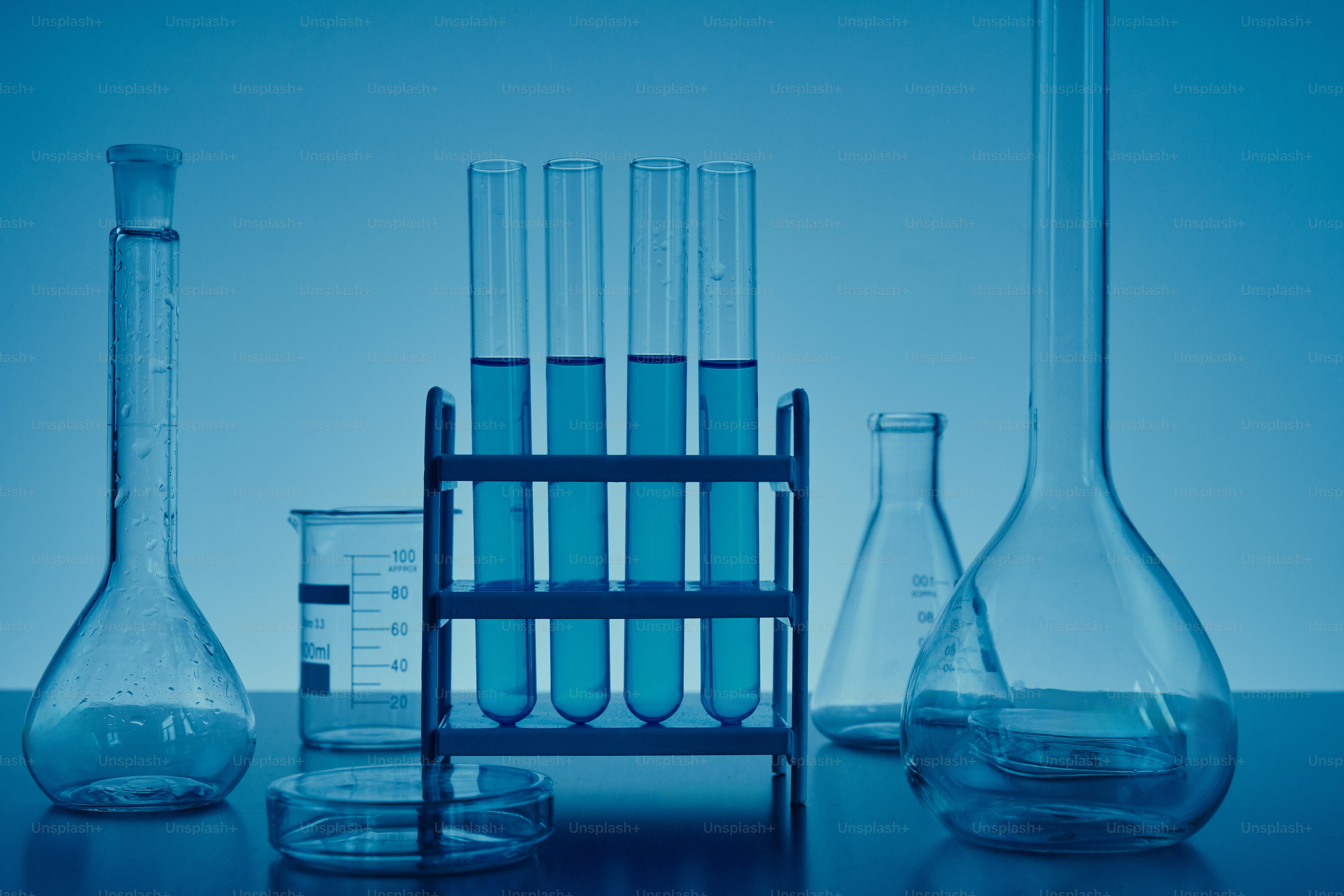 Laboratory glassware with blue liquid on a blue background photo ...