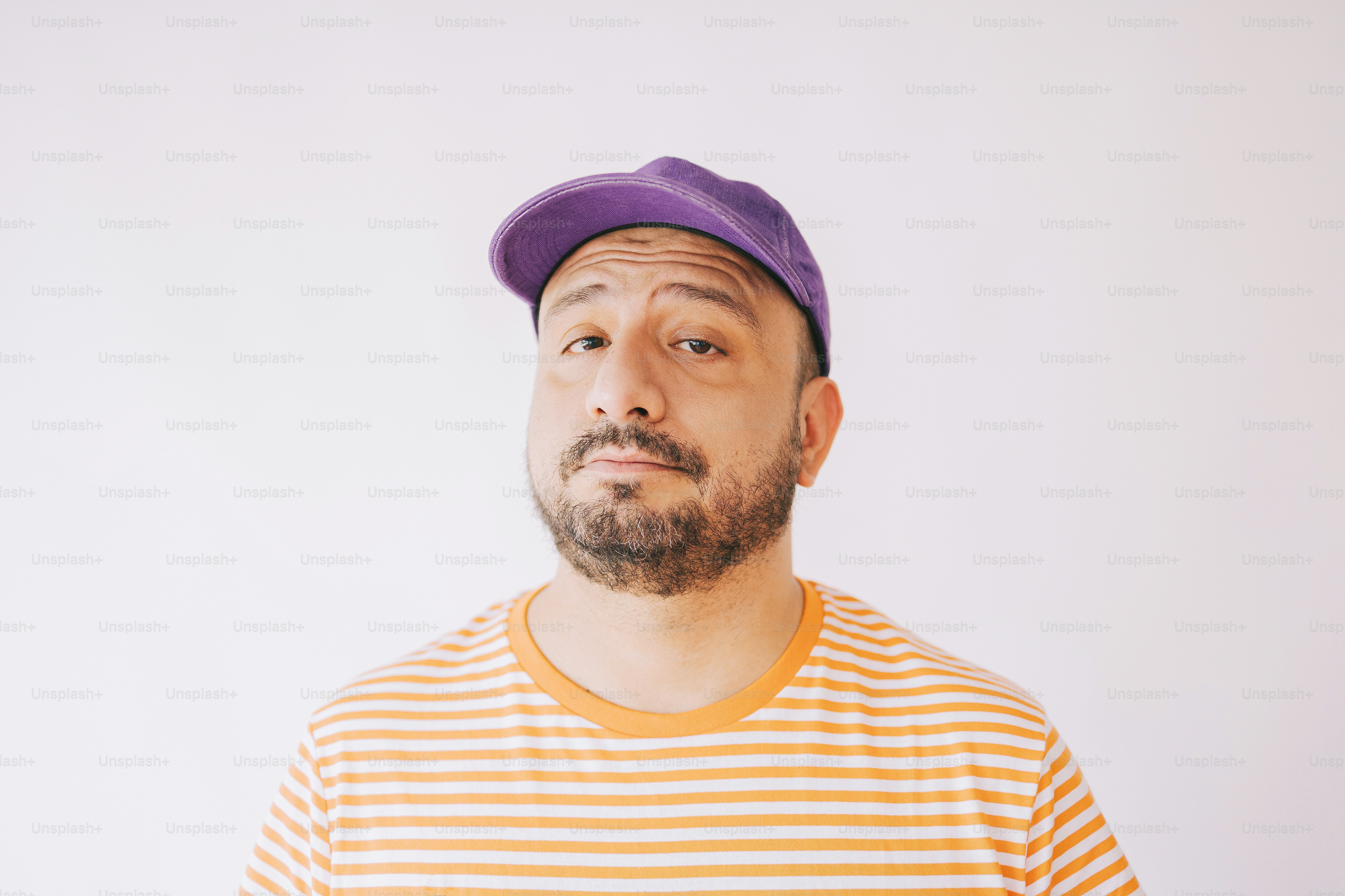 Man wearing a purple cap and striped shirt. photo – Portrait Image on ...