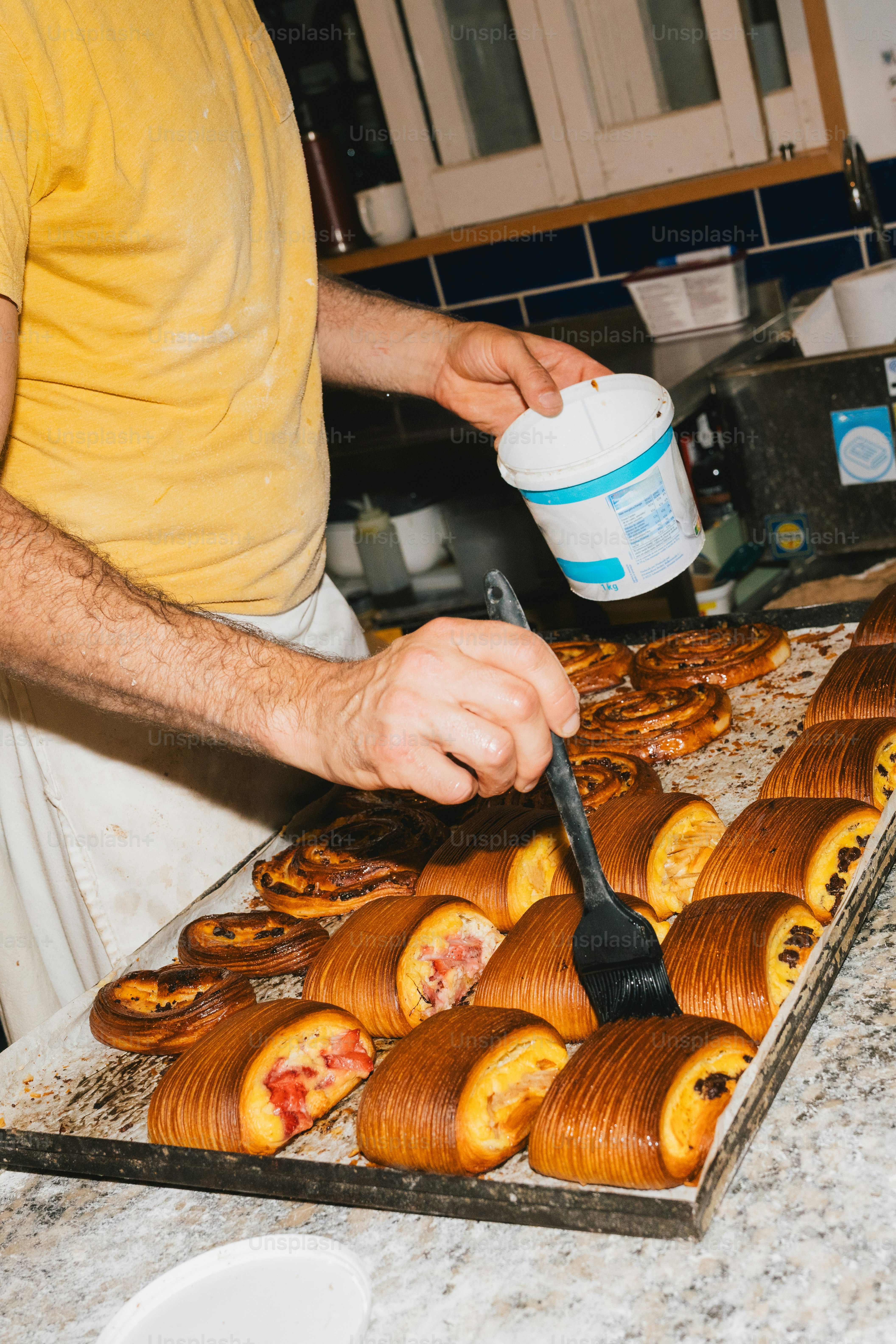 Baker dusting flour on a large work surface photo – Bakery Image on ...