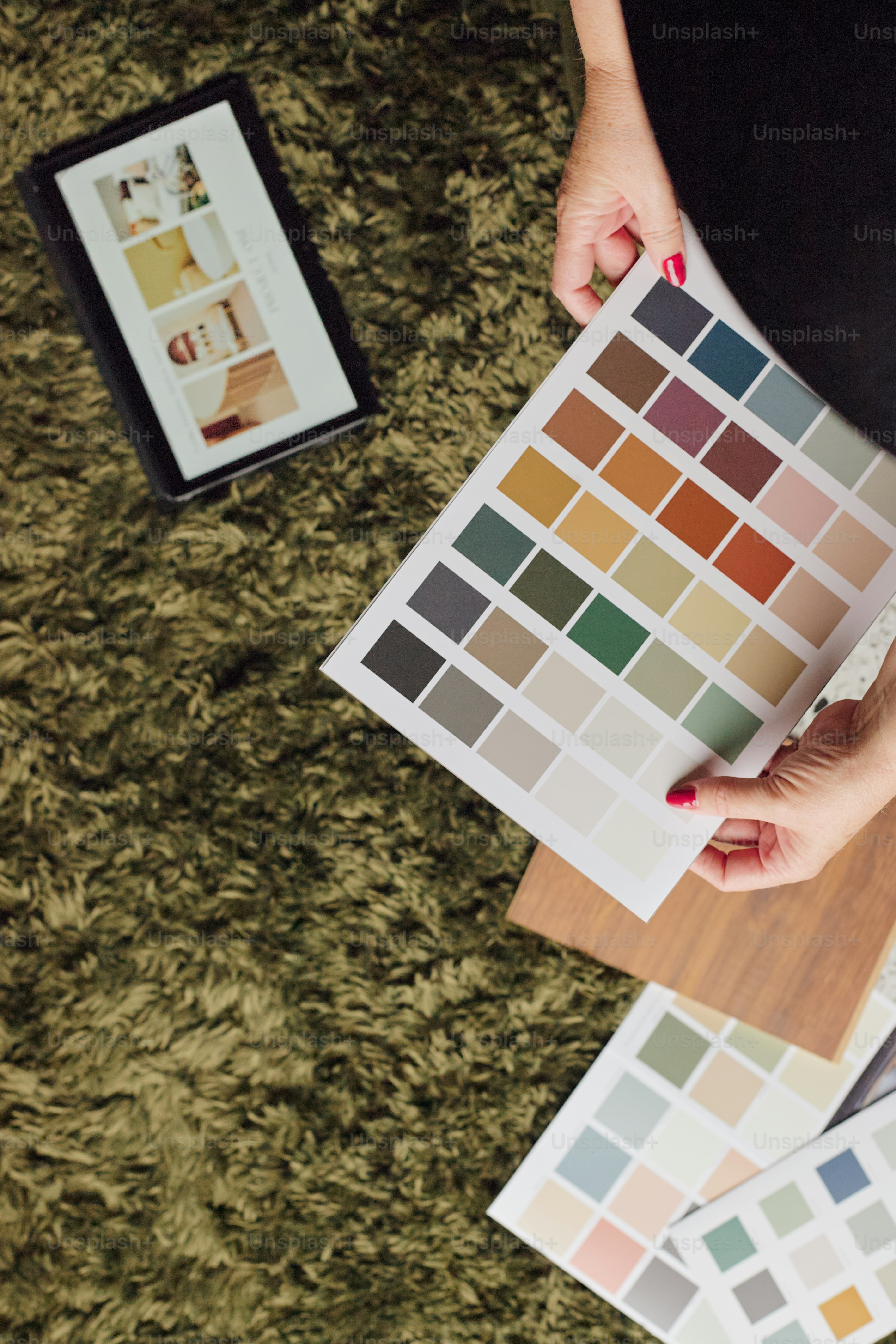Hands holding color swatches and tablet with interior design. photo ...