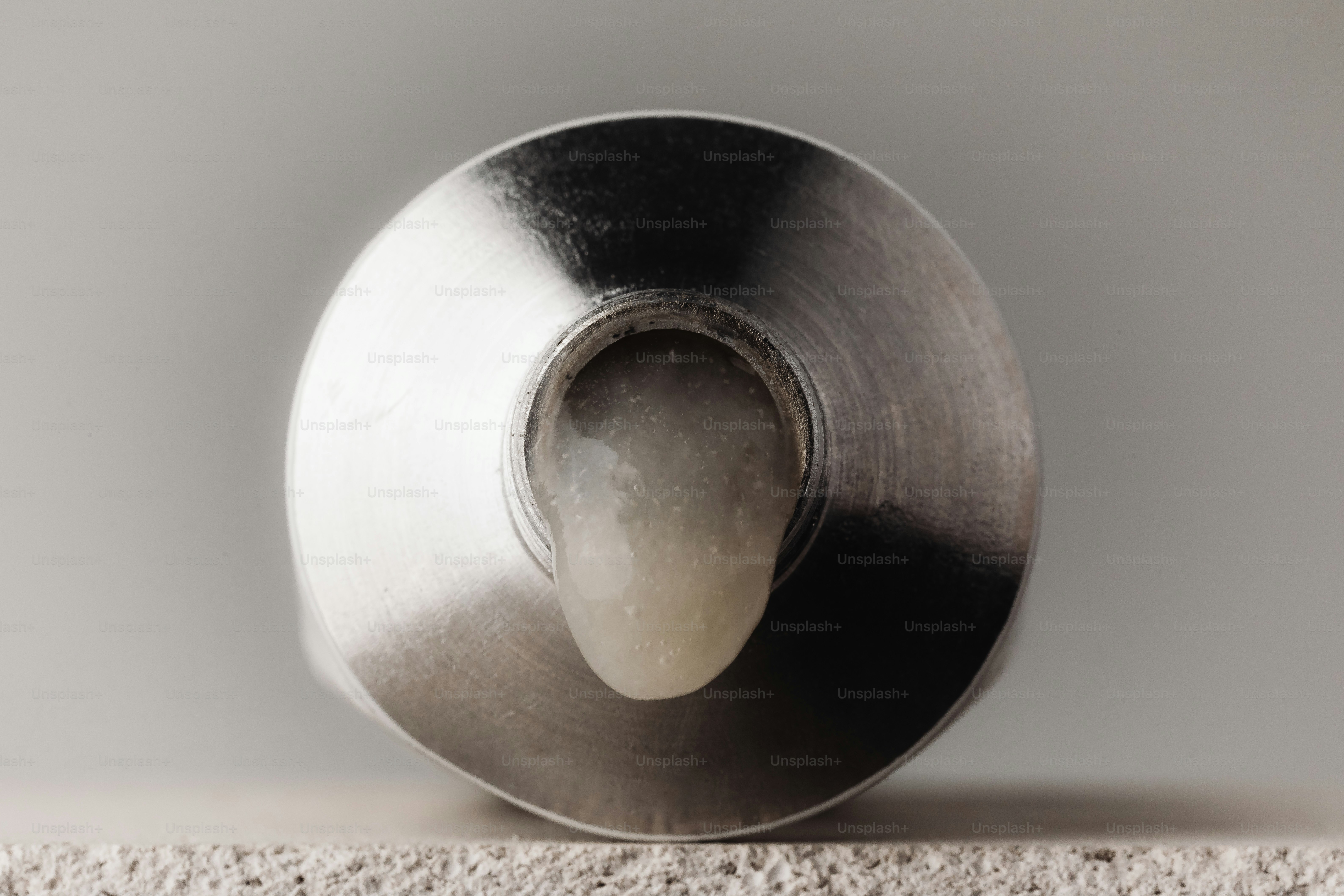 Close-up of a metal tube with cream oozing out. photo – Macro Image on ...