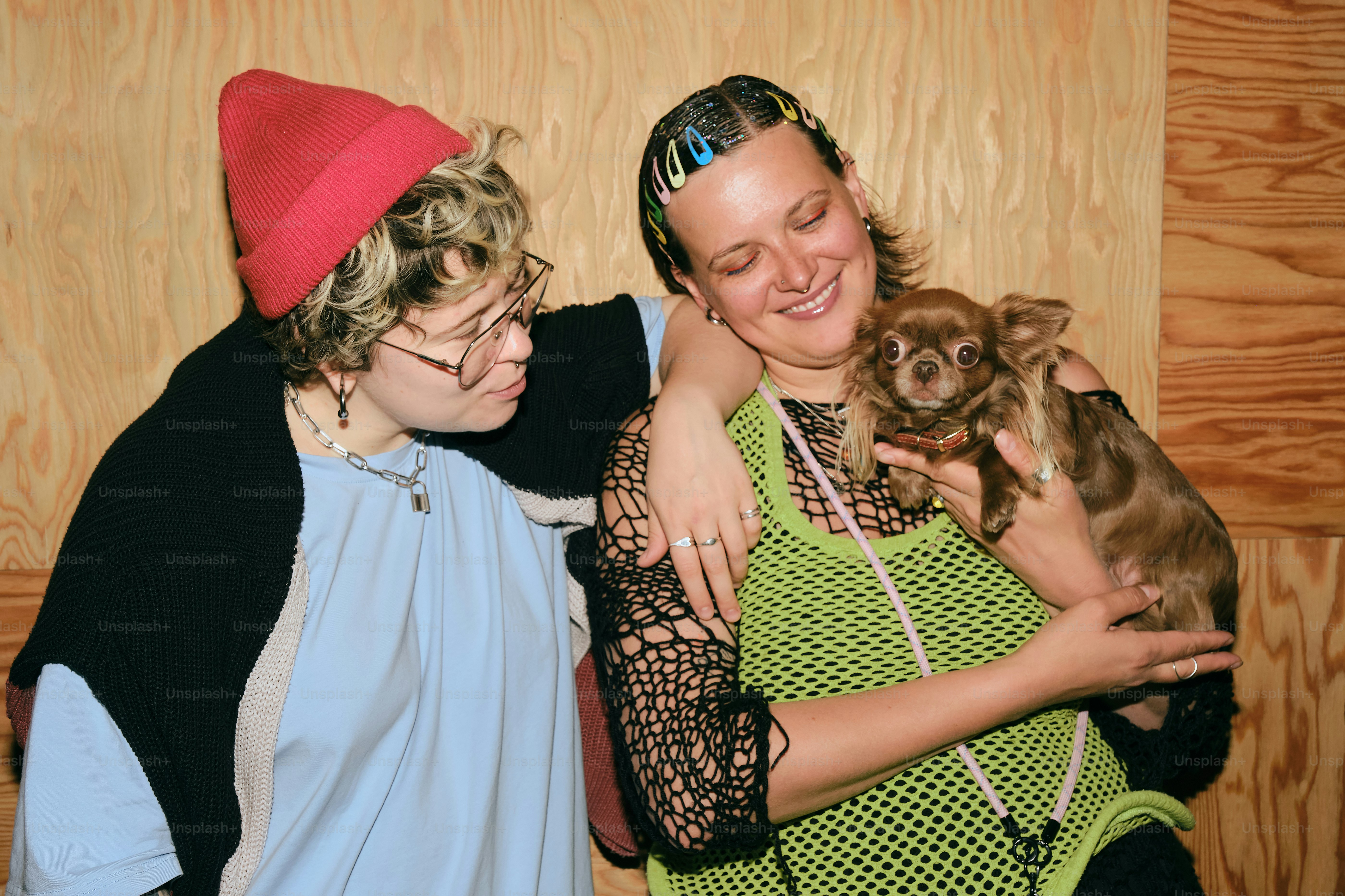 Two women holding a small chihuahua dog photo – Portrait Image on Unsplash