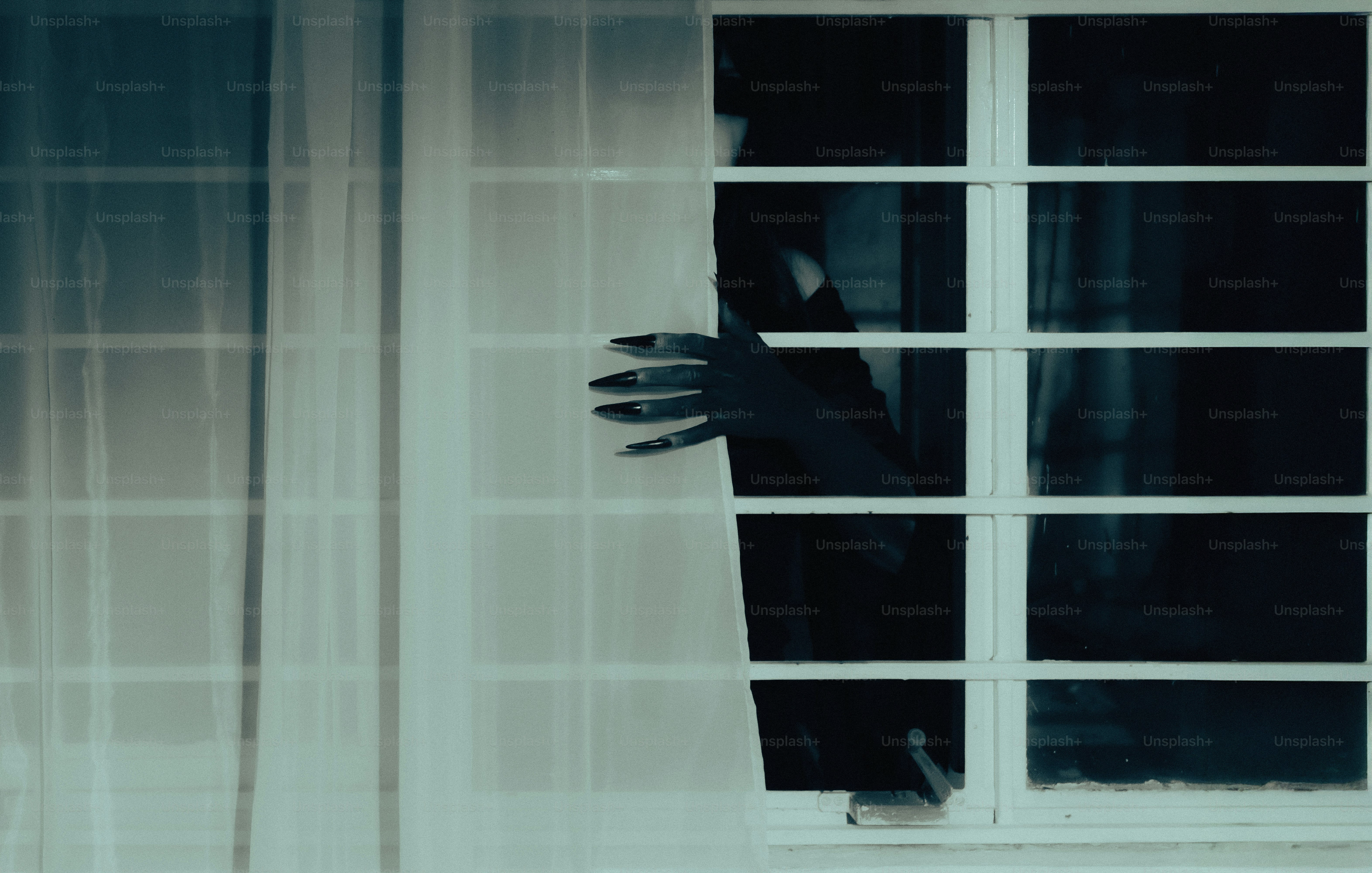 A shadowy figure peeks through window blinds photo – Dark Image on Unsplash