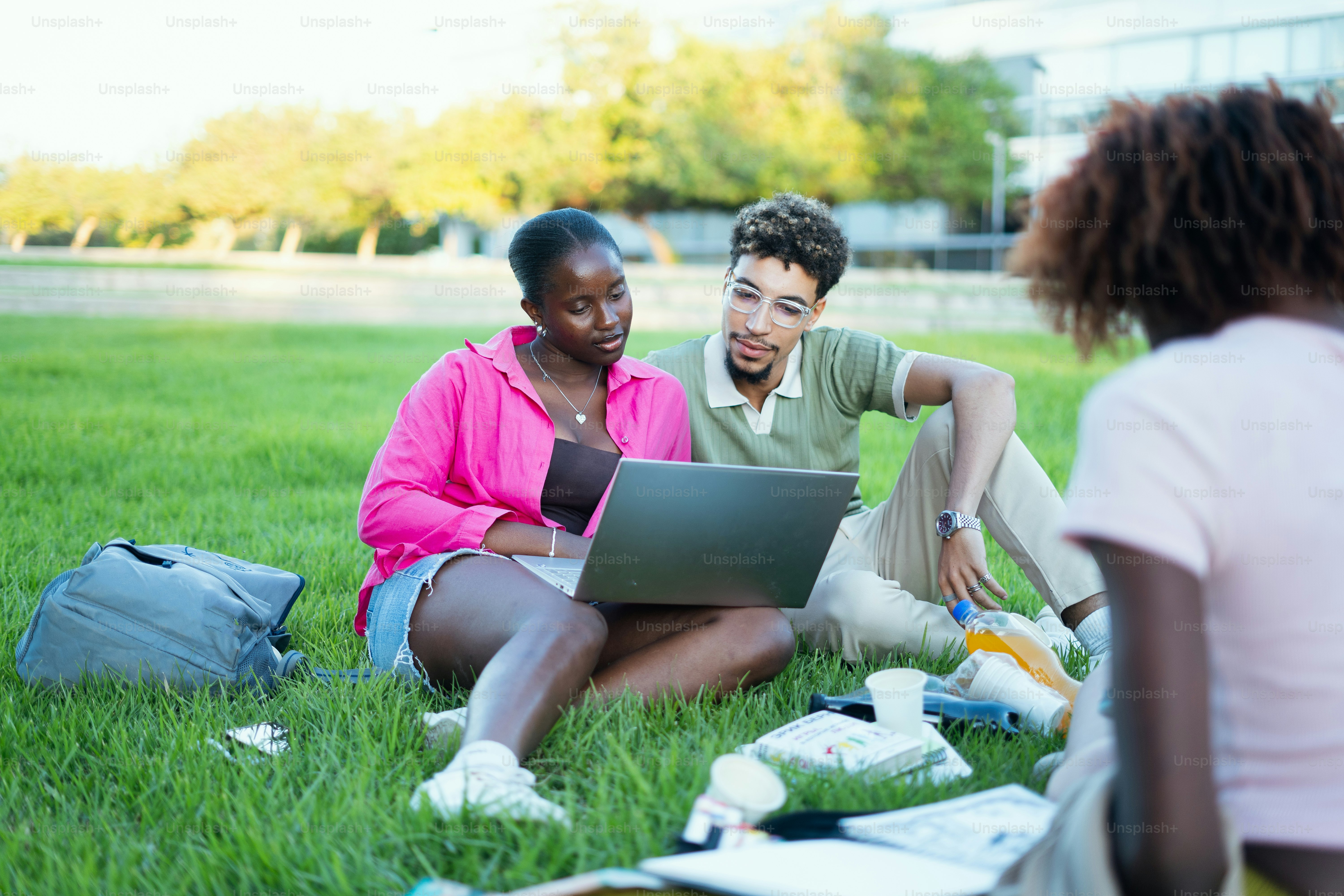 Three students working on a laptop outdoors photo – Technology Image on ...