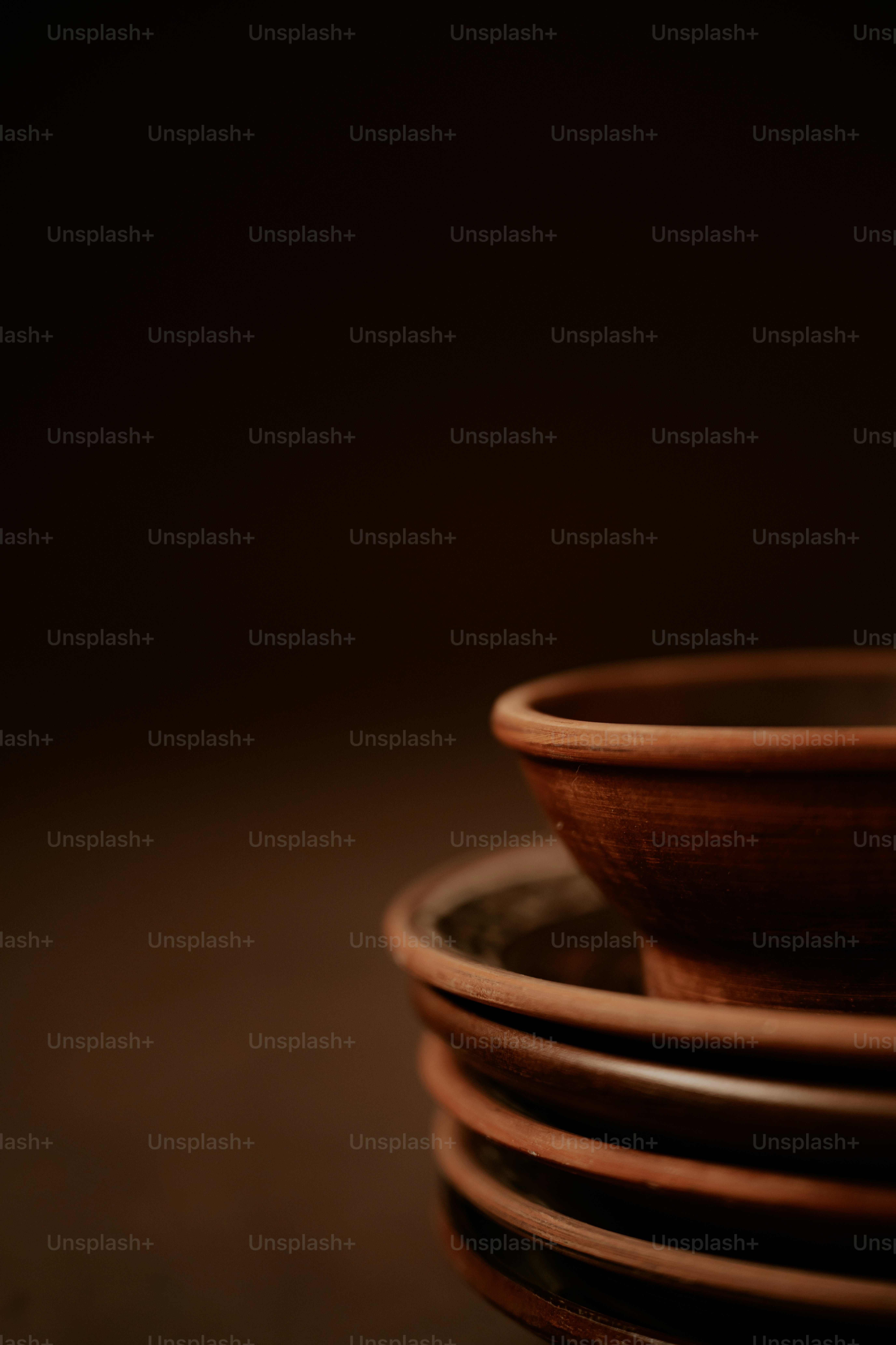 Several rustic ceramic plates and bowls arranged together. photo ...