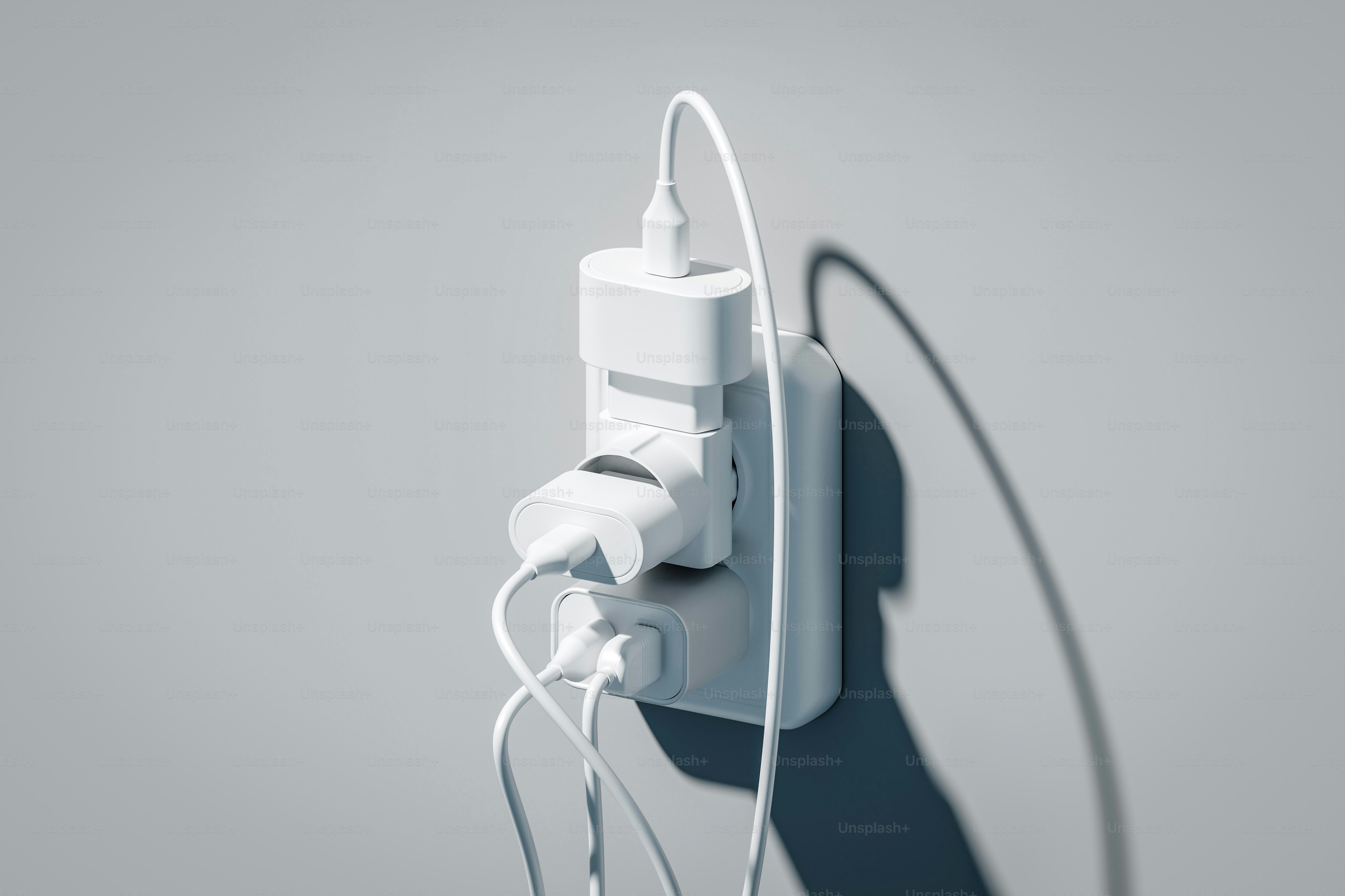 Multiple white power adapters plugged into wall outlet. photo – 3d ...