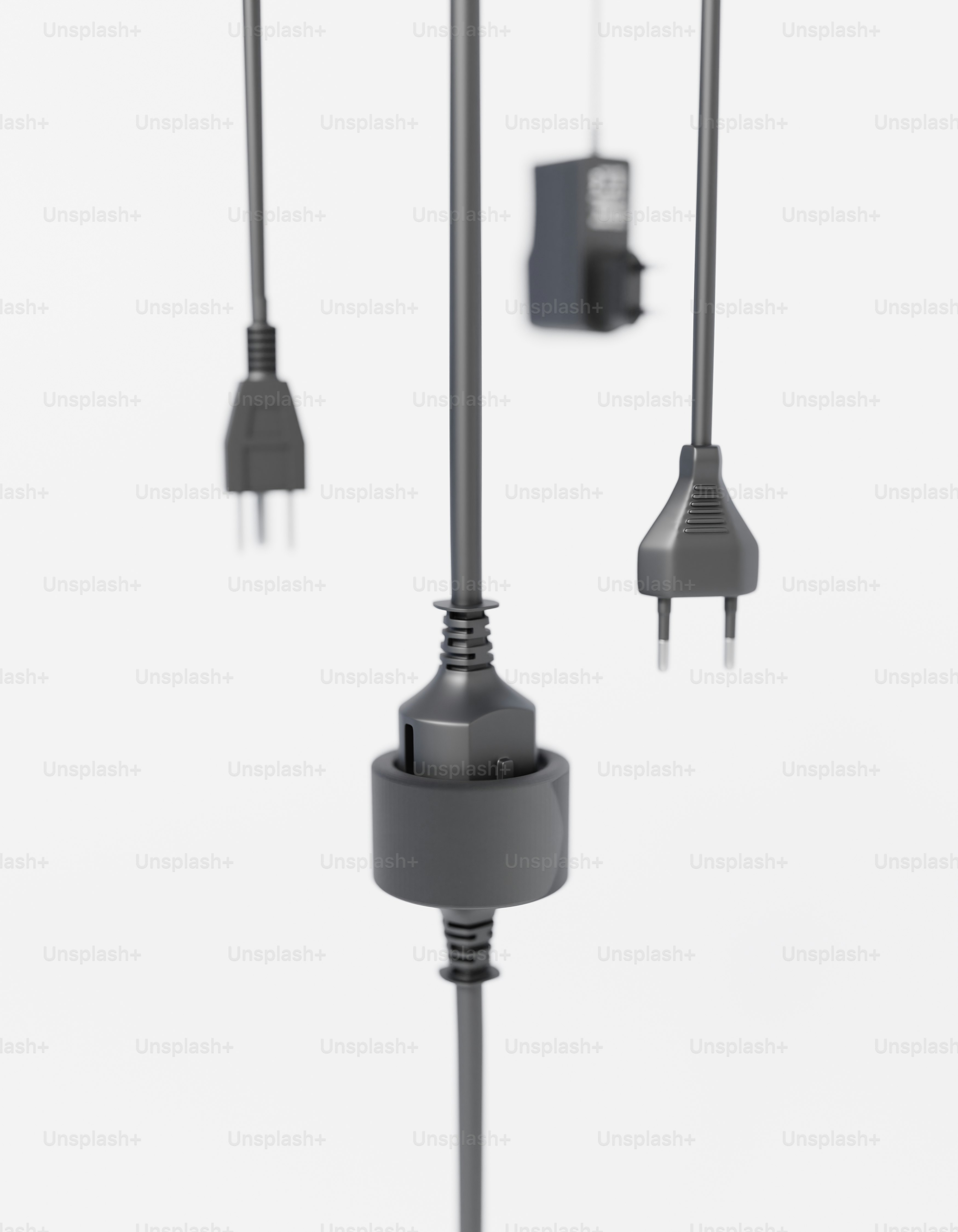 Several electrical plugs and cords hanging photo – Minimalist Image on ...