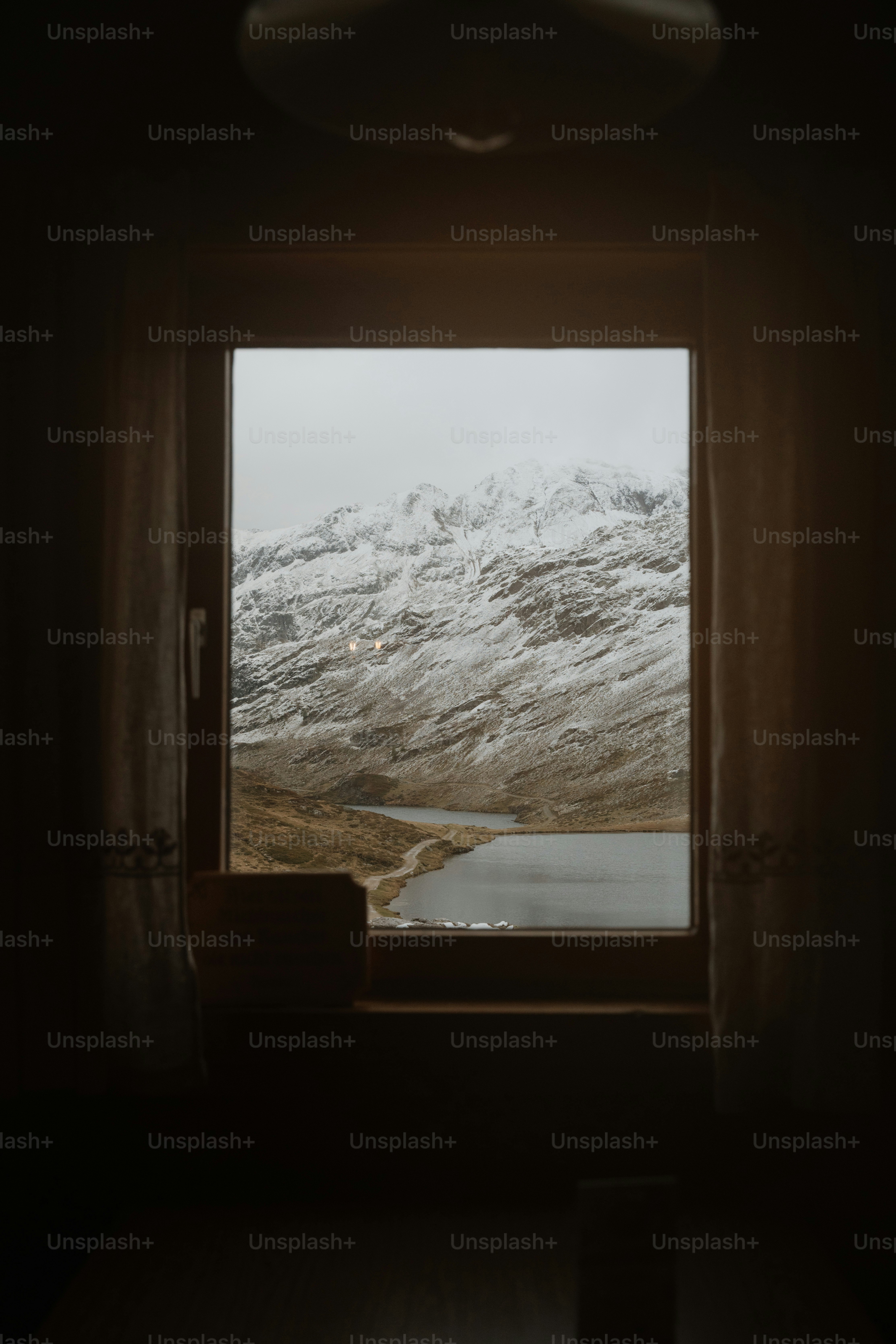 Snowy mountain landscape seen through a window photo – Winter Image on ...