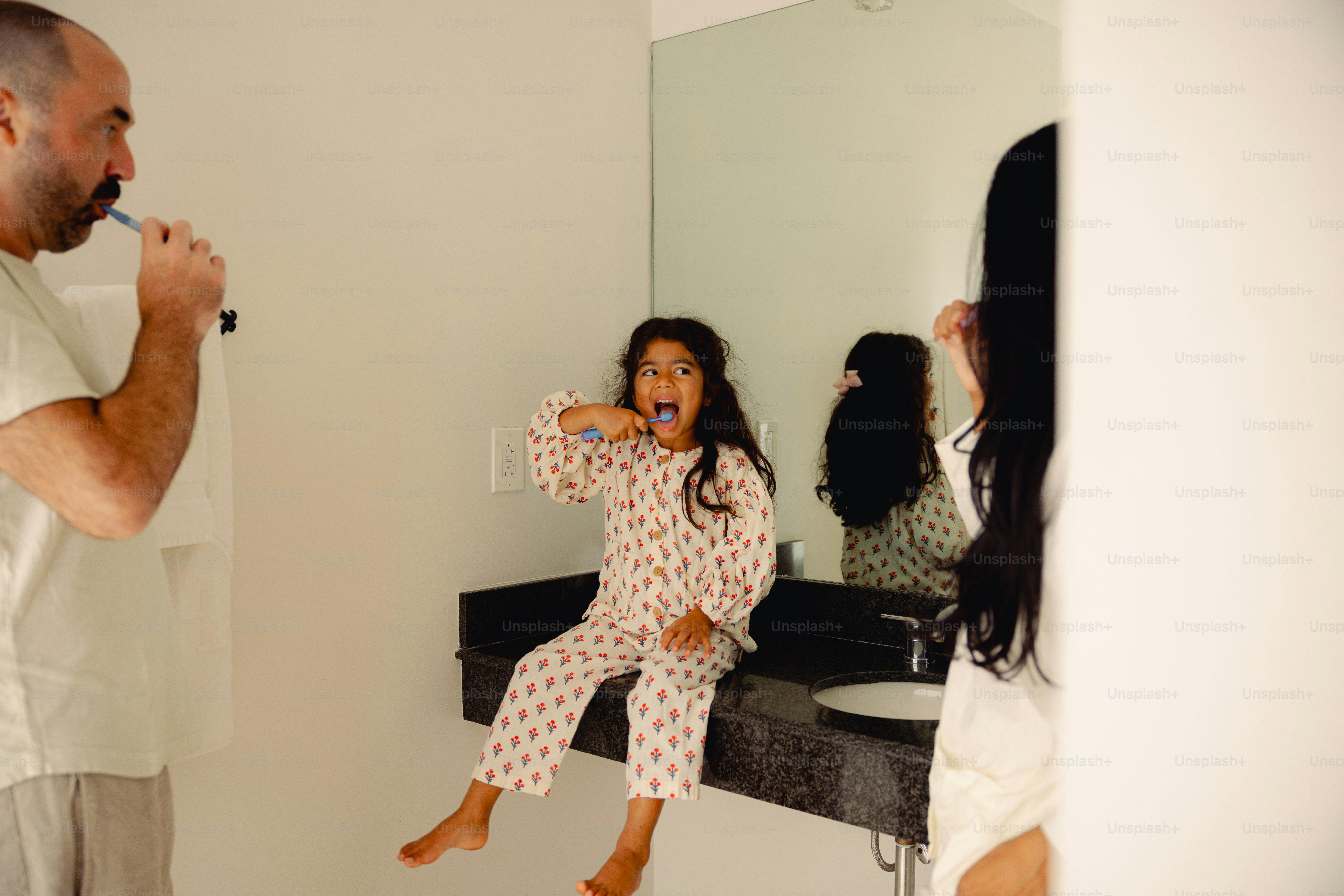 Family brushing teeth together in bathroom photo – Travel Image on Unsplash