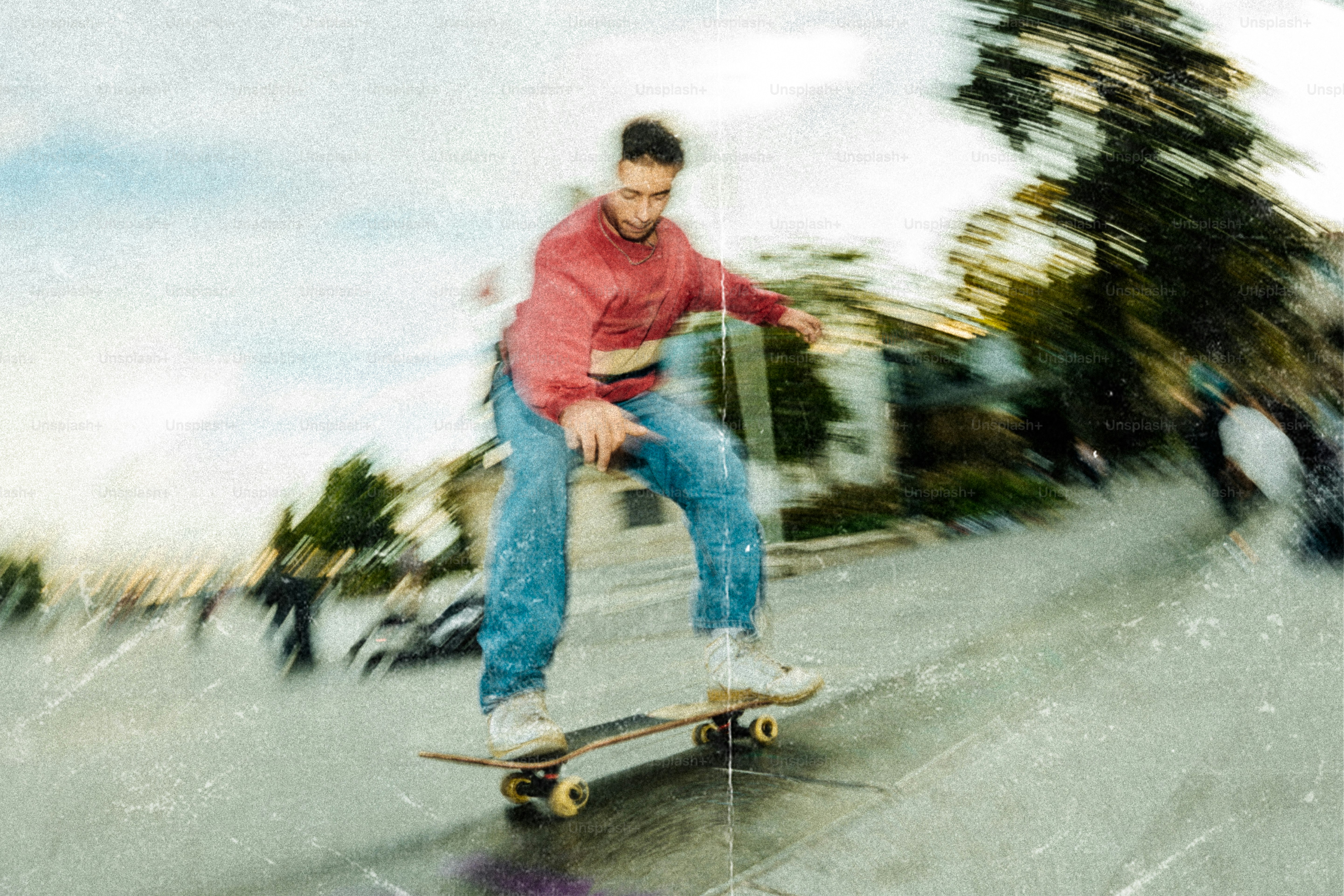 Young man skateboarding down a suburban street photo – Skateboard Image ...