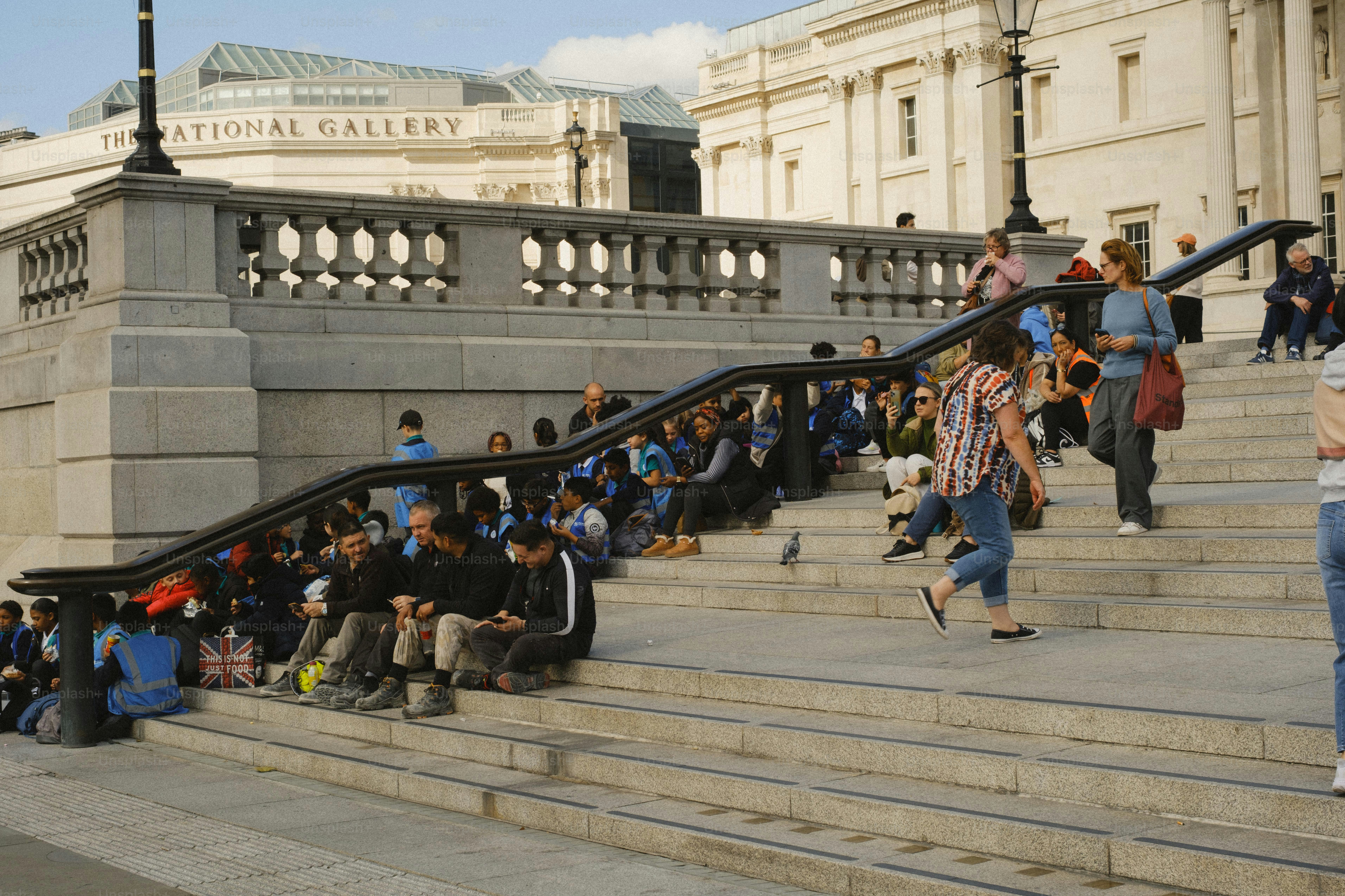 People sitting on steps outside national gallery, london photo – City ...
