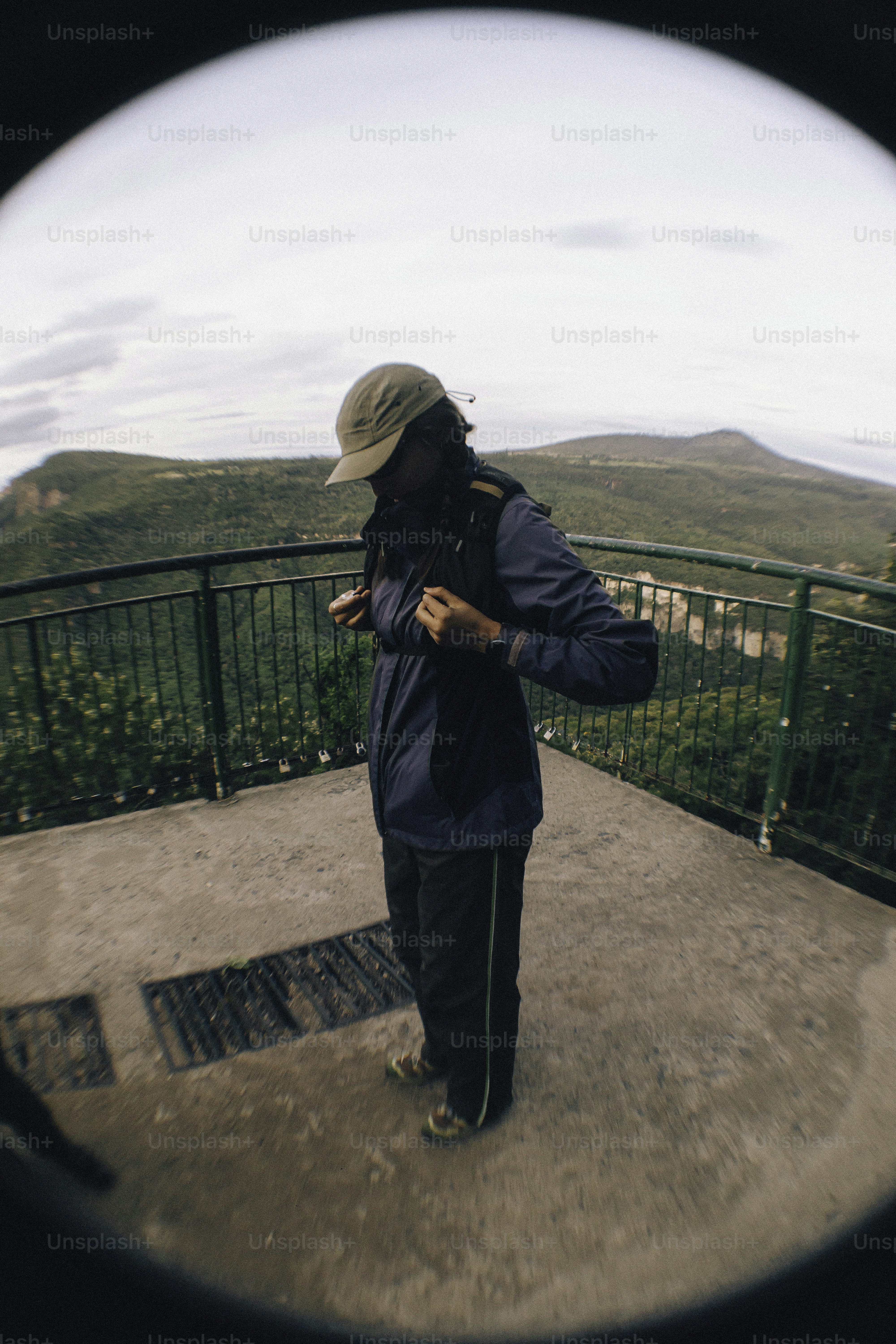 Person in a cap and jacket on a scenic overlook photo – Travel Image on ...