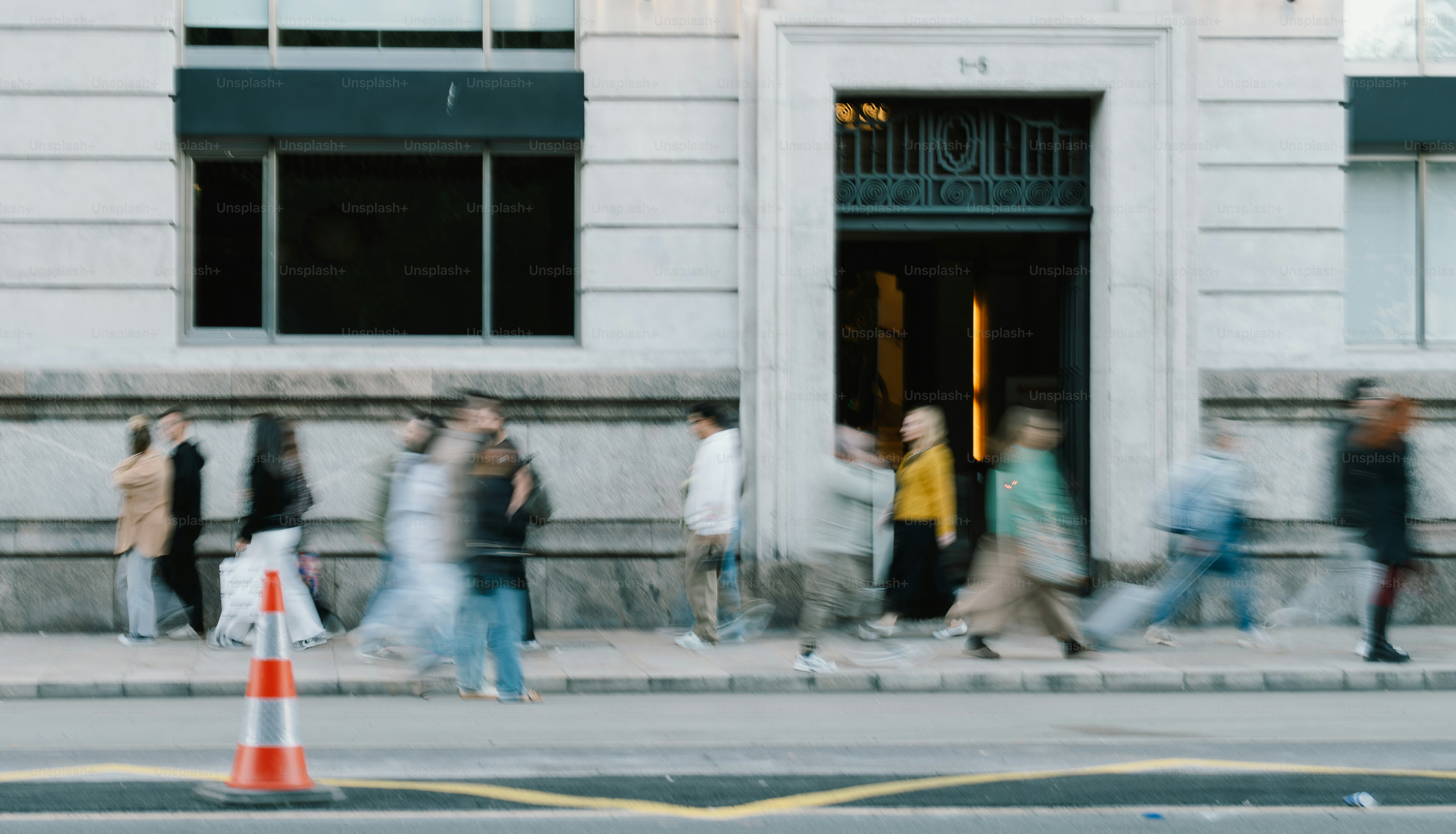 Blurred figures of people walking on a sidewalk photo – Walking Image ...