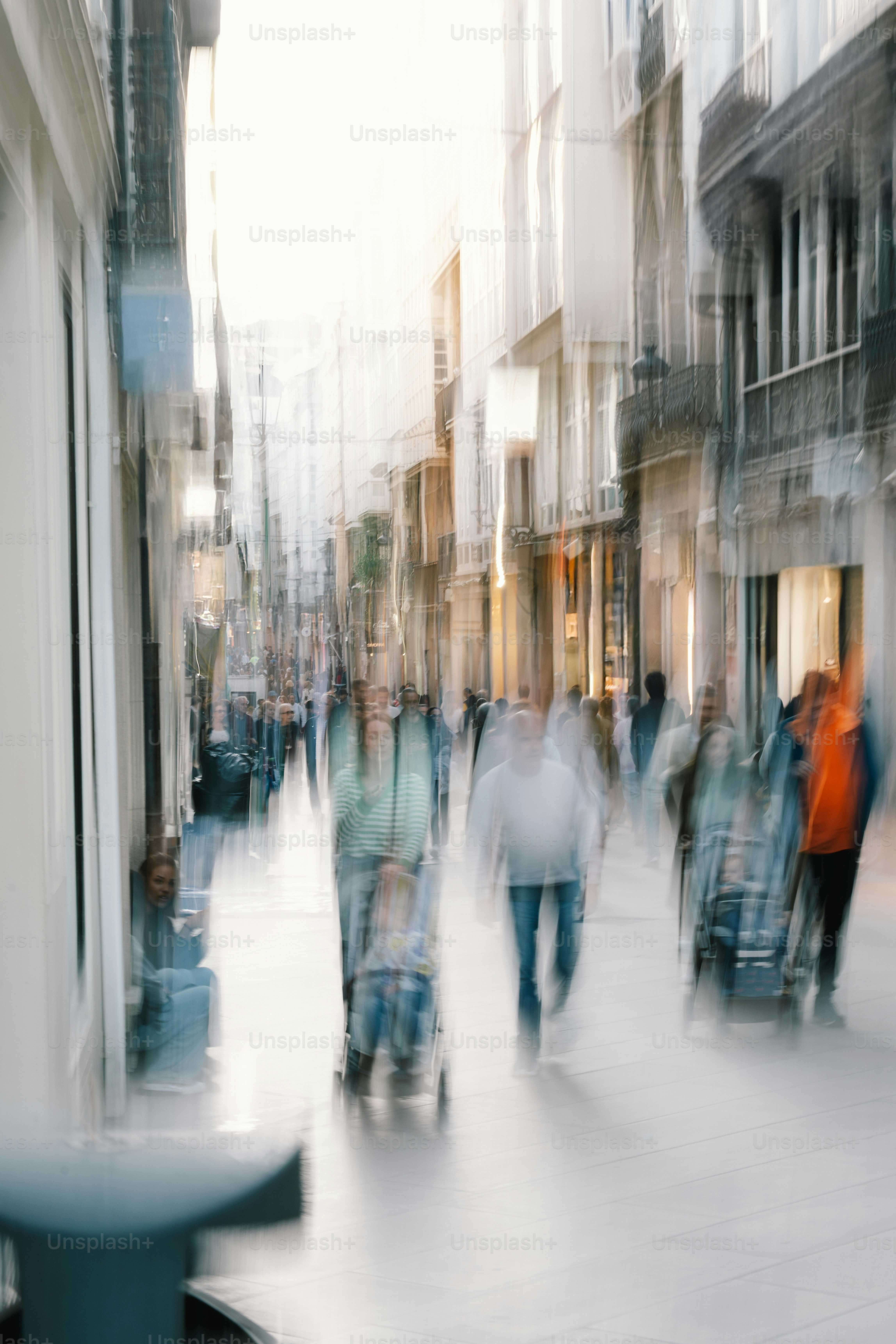 Blurred figures walking down a sunlit street photo – Walking Image on ...