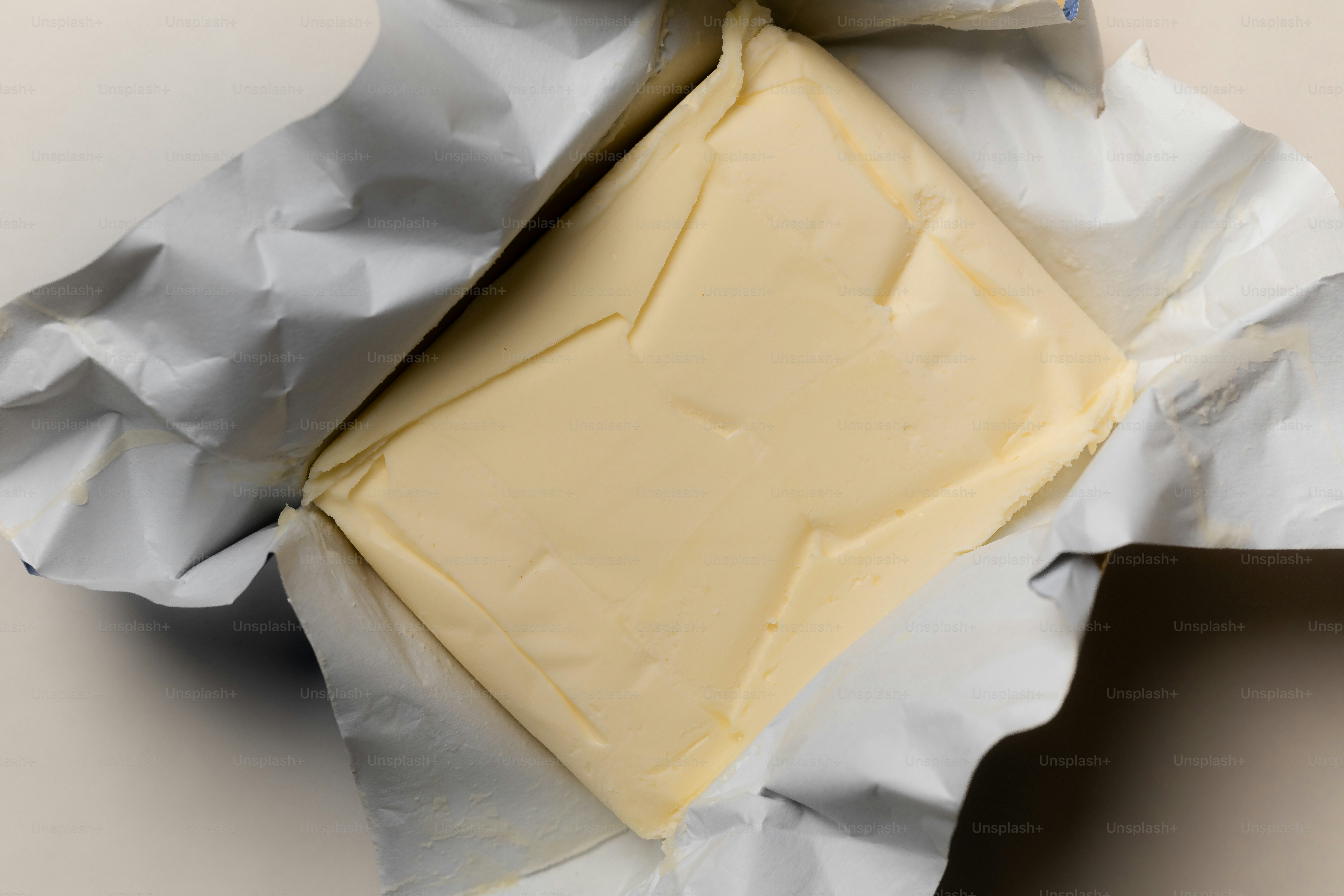 A stick of butter unwrapped in foil photo – Butter Image on Unsplash