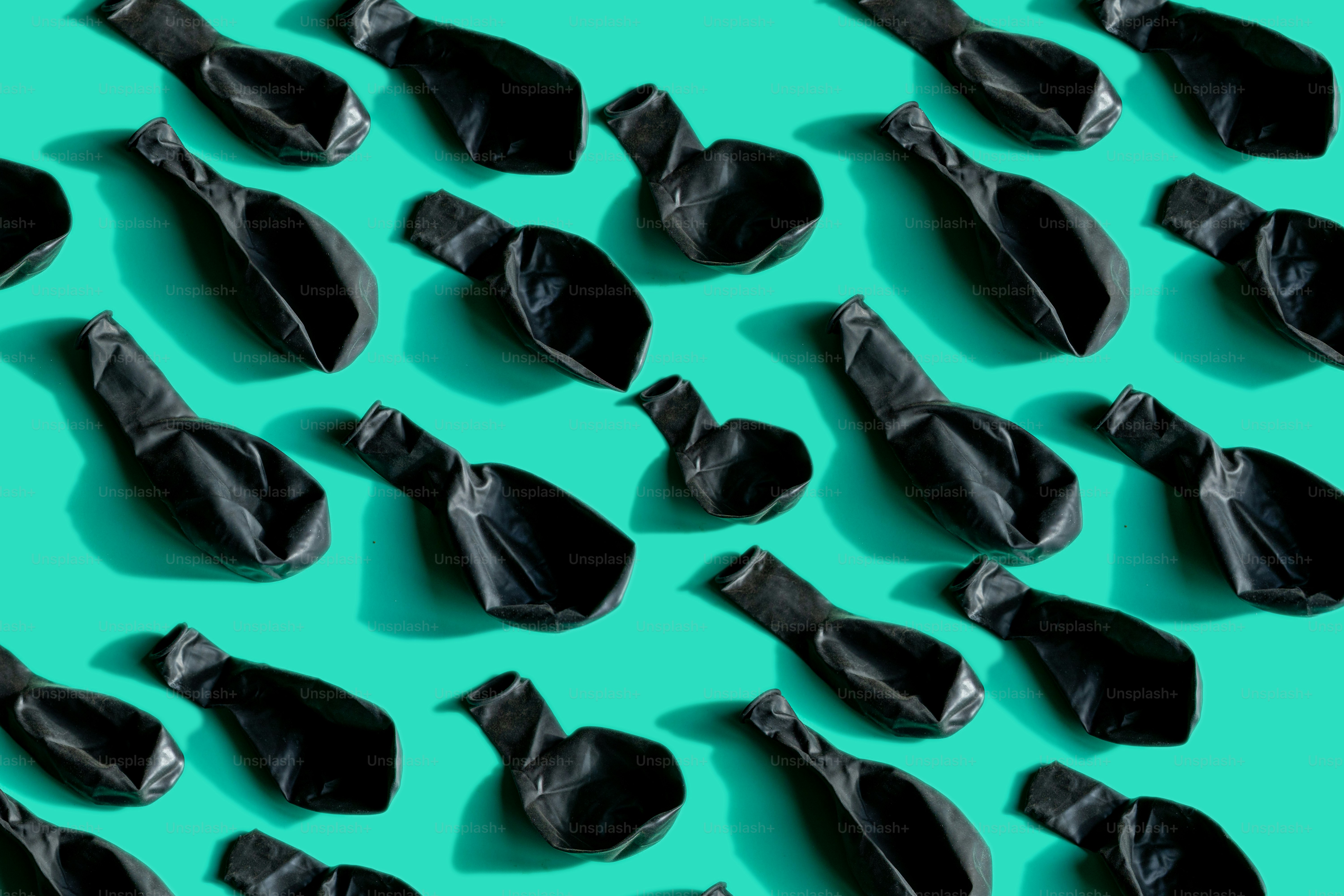 Many deflated black balloons on a teal background. photo – Wallpaper ...