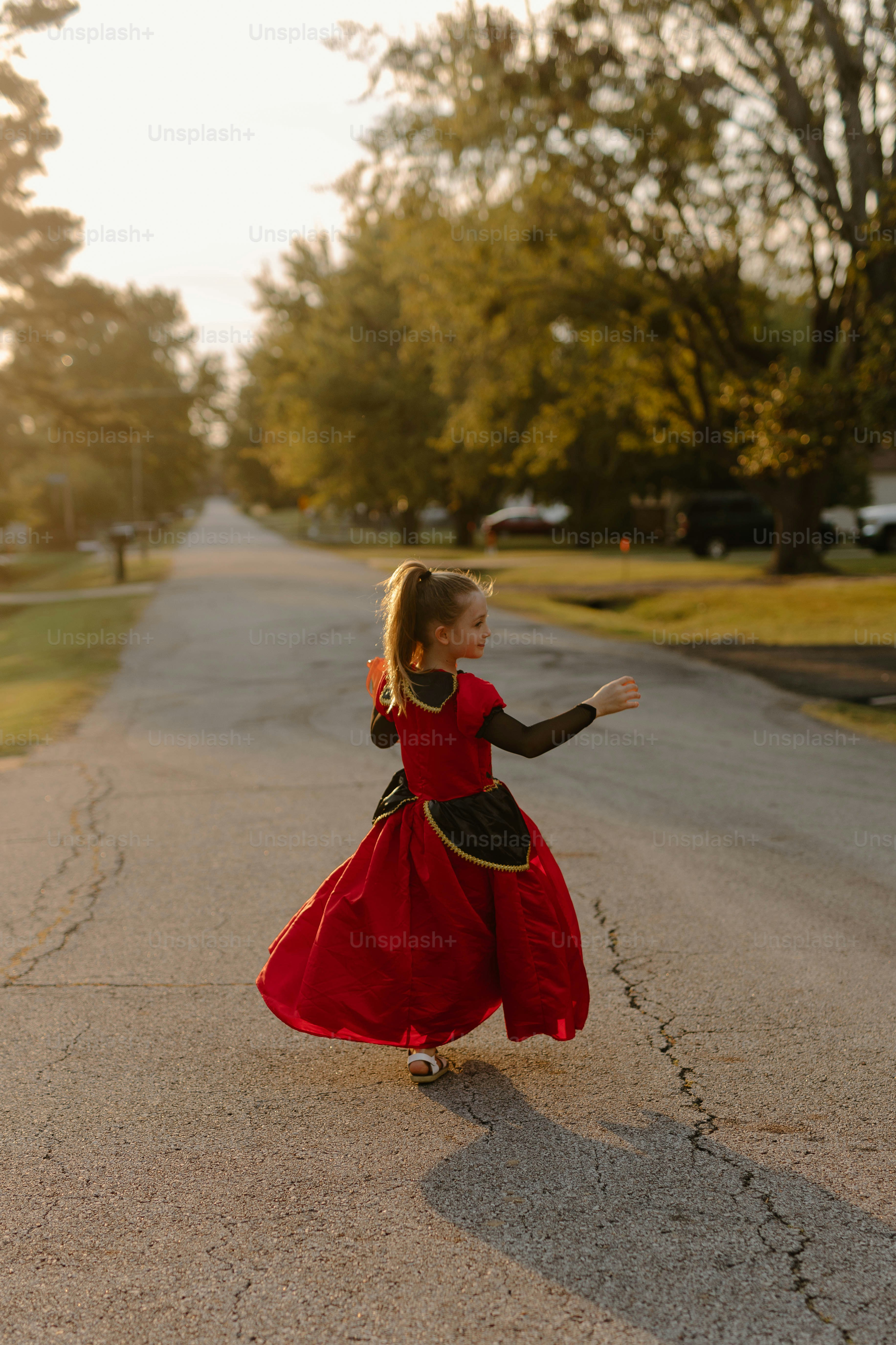 Young girl in red dress walks down street photo – Girl Image on Unsplash