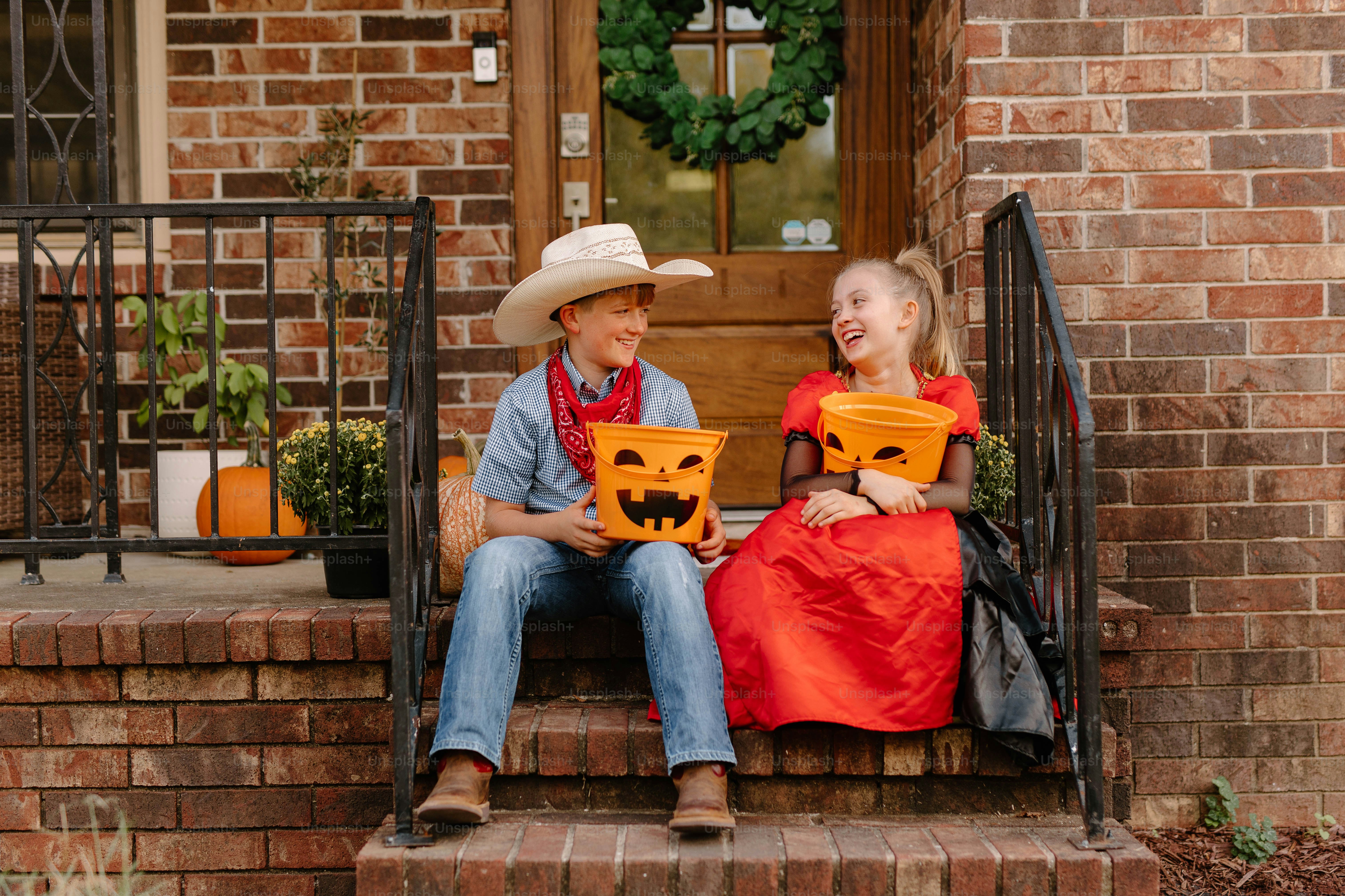 Two children in costumes holding candy buckets photo – Autumn Image on ...