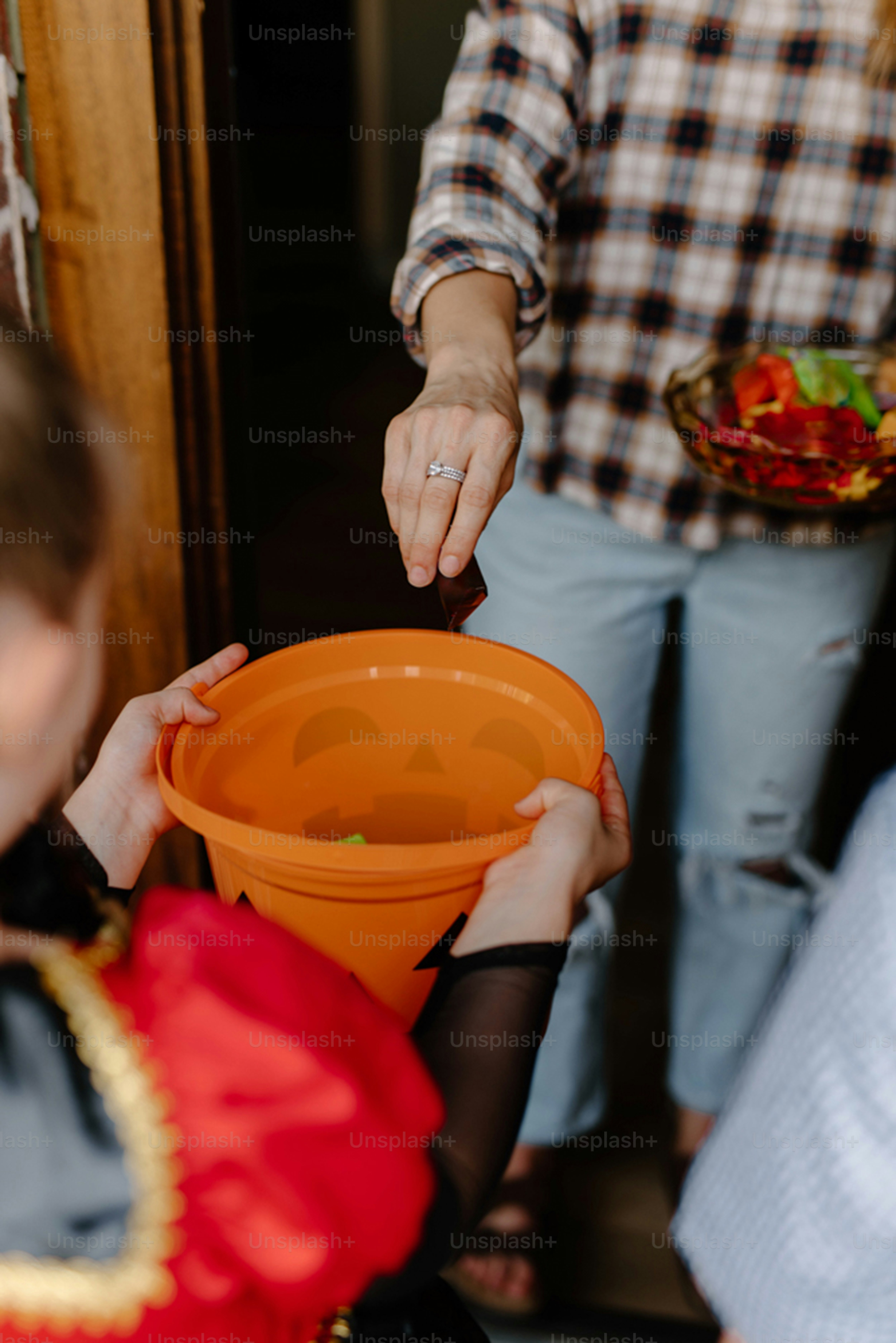 Person giving candy to child in halloween costume photo – Autumn Image ...
