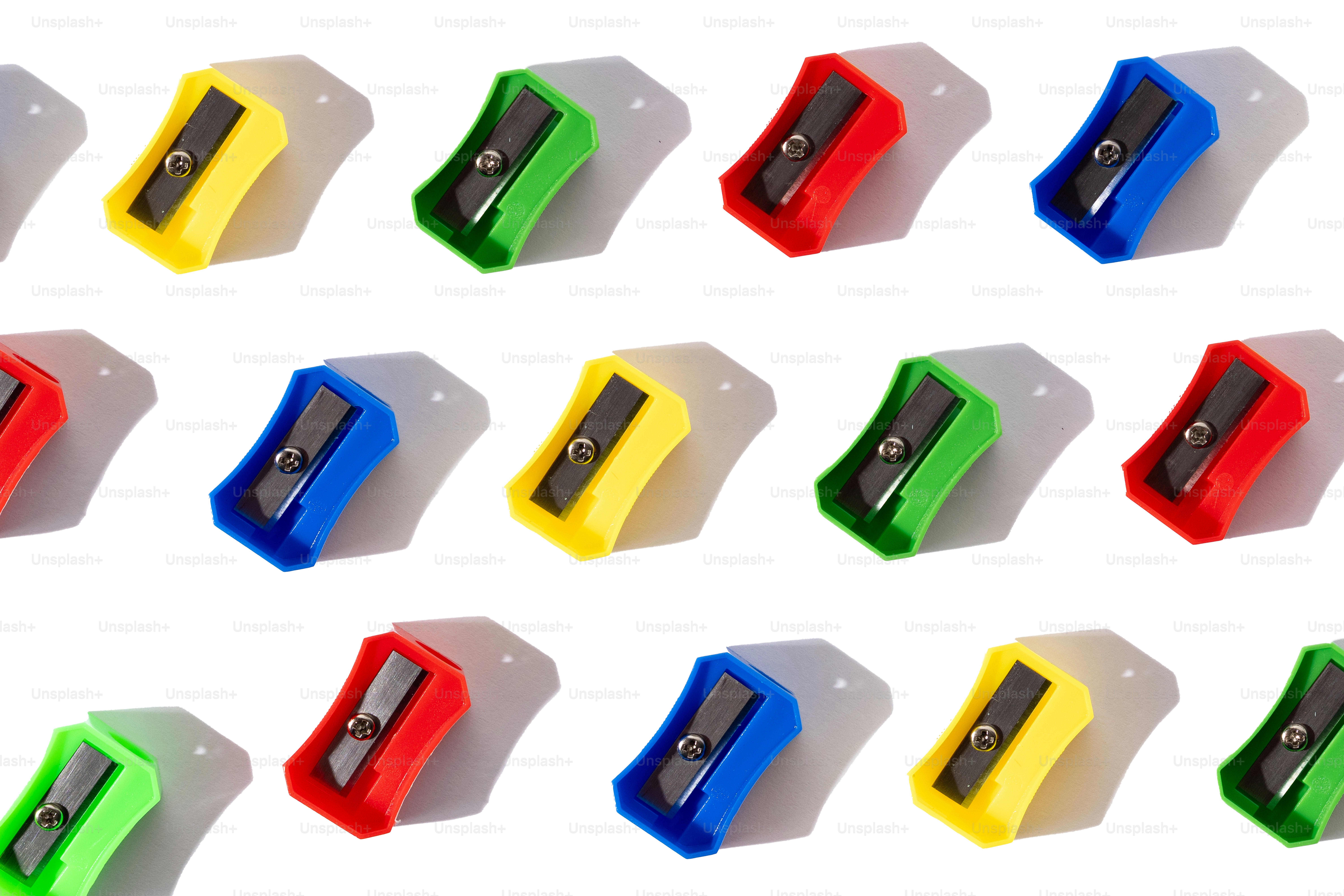 Colorful pencil sharpeners arranged in rows photo – Office Image on ...