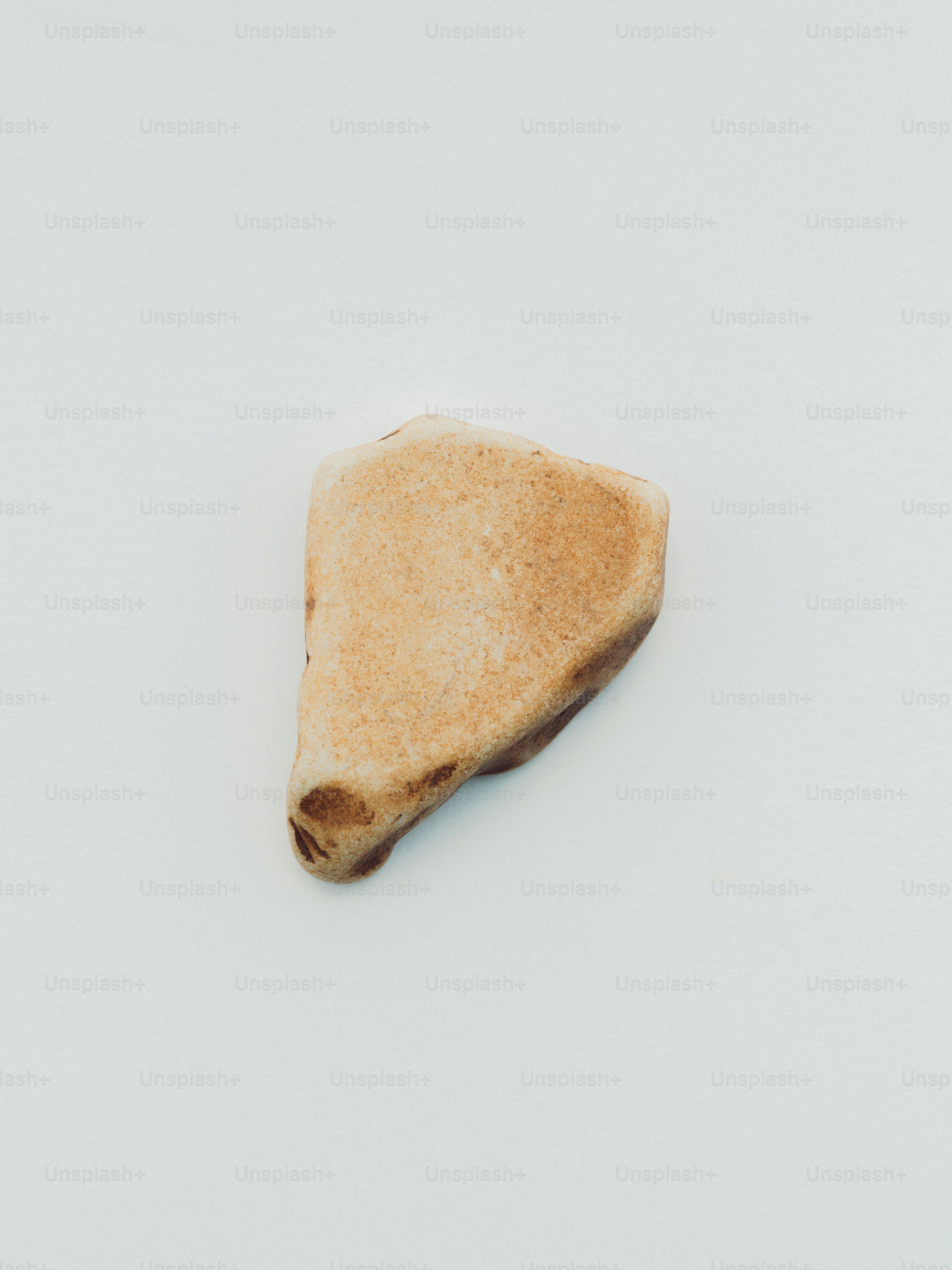 A single light-colored stone with brown markings. photo – Minimal Image ...