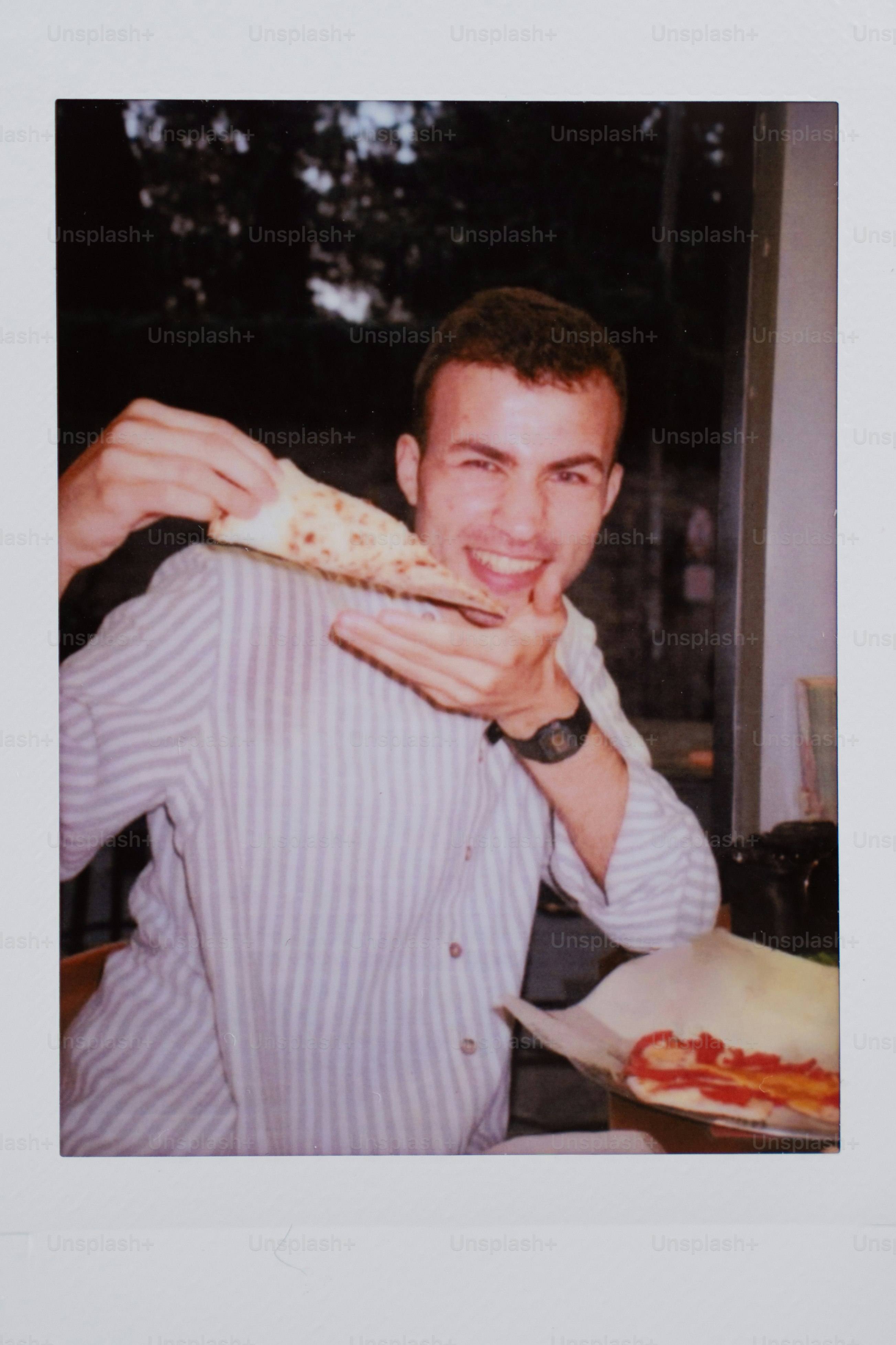 Man happily eating a slice of pizza photo – Pizza Image on Unsplash