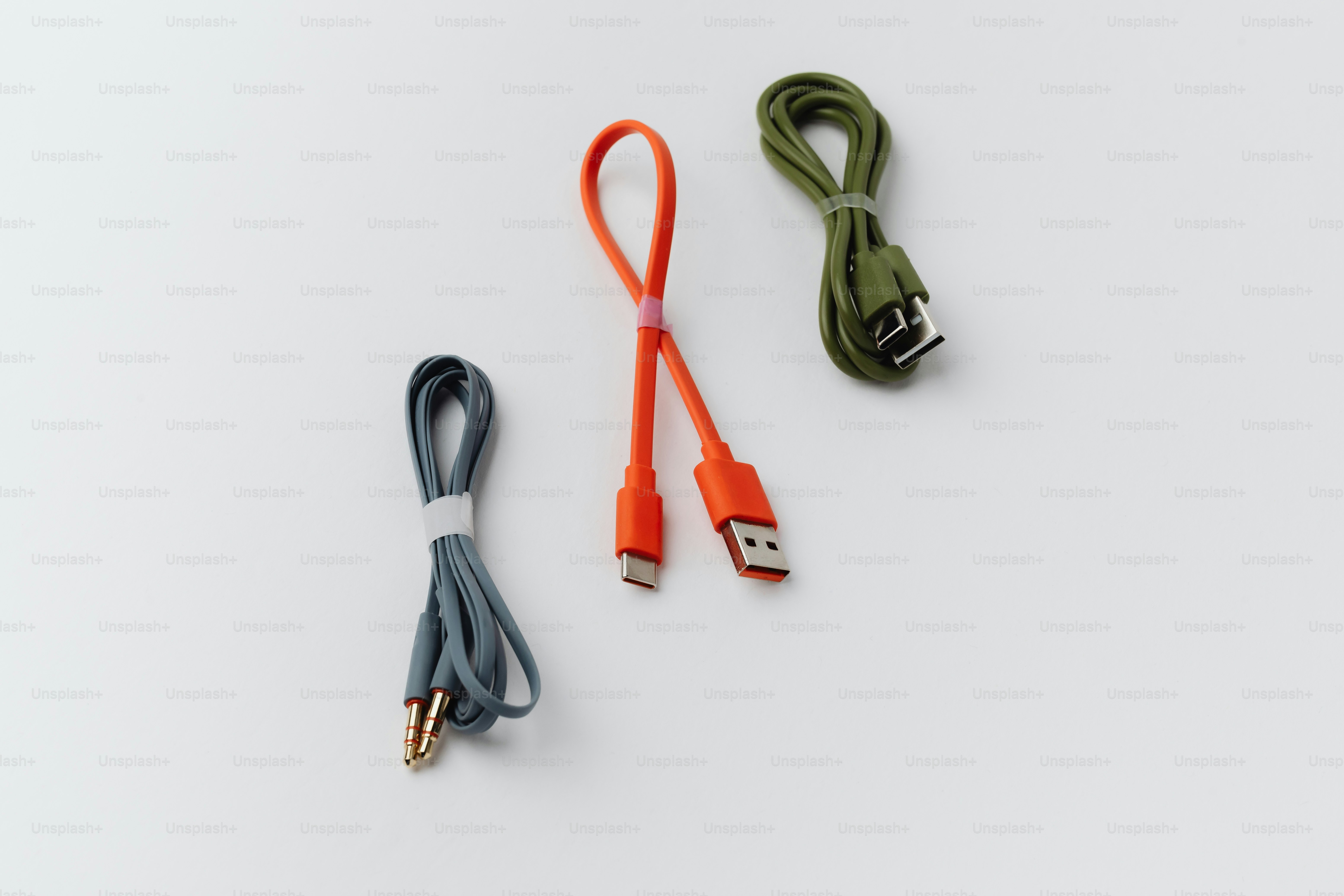 Various electronic cables with different connectors on white background ...