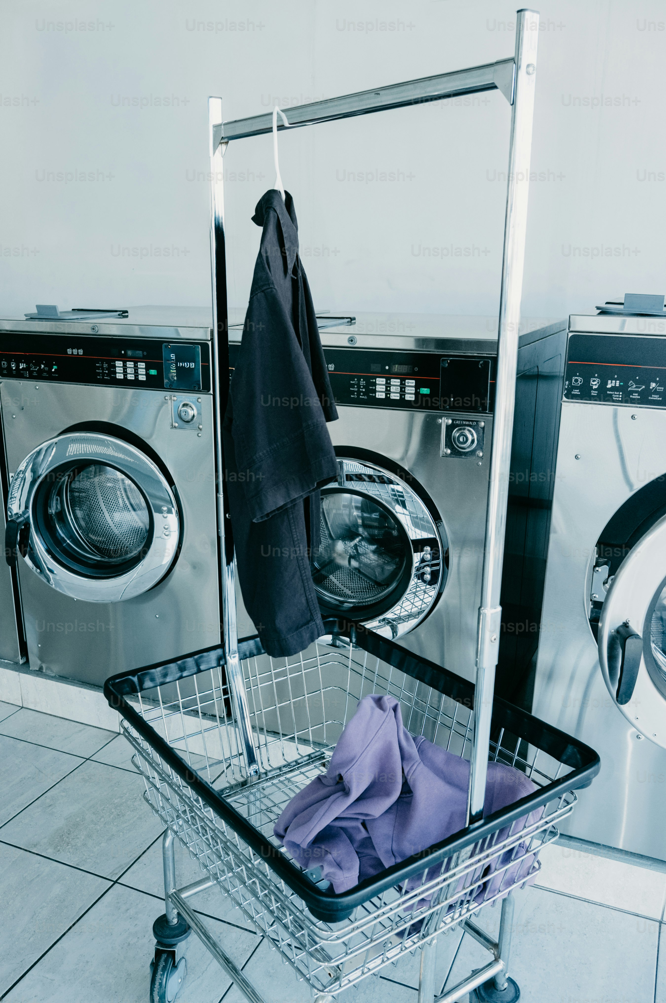 Woman with tote bag standing by washing machines photo – Vintage Image ...