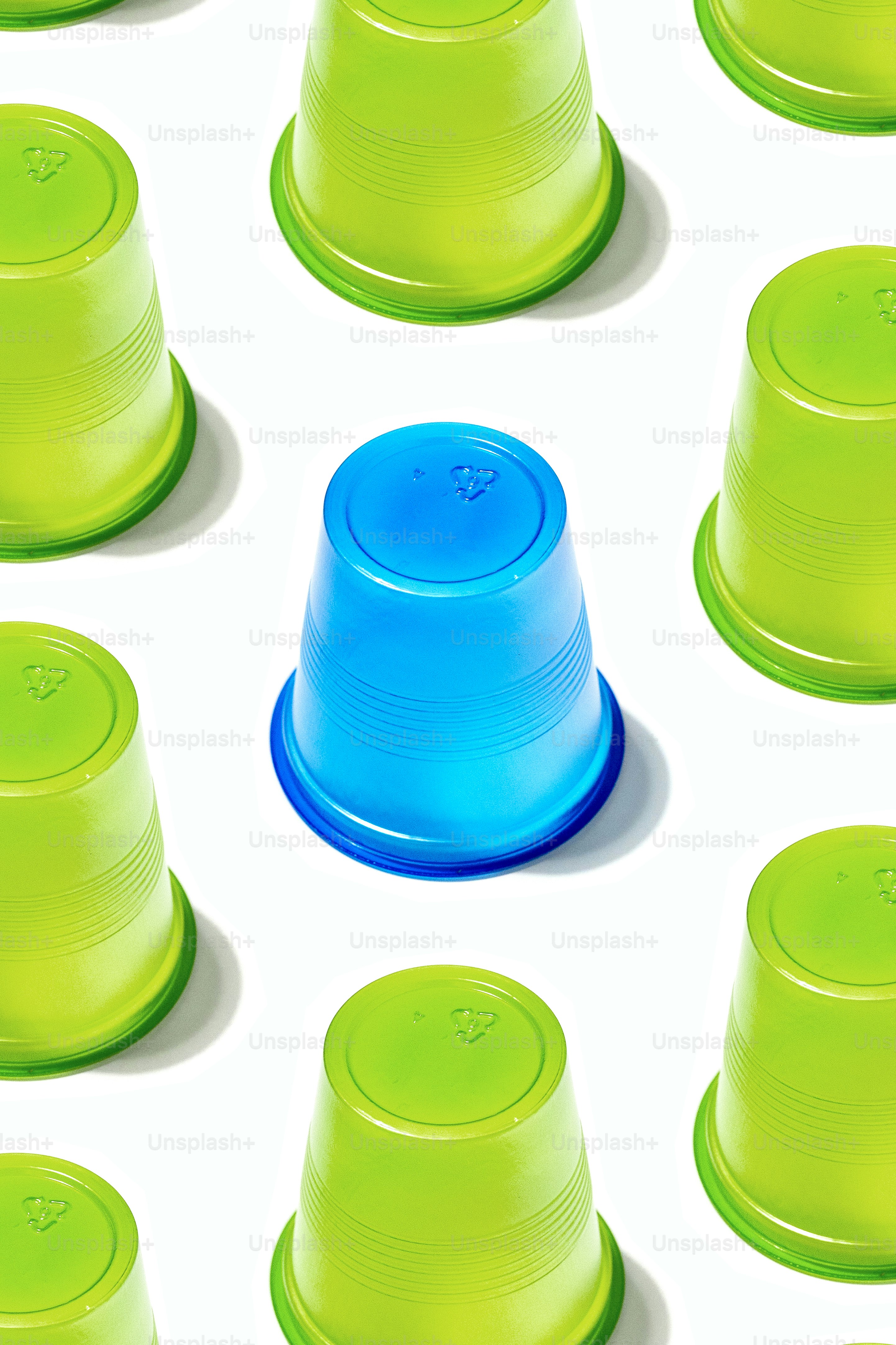 A blue cup stands out among green cups. photo – Blue Image on Unsplash