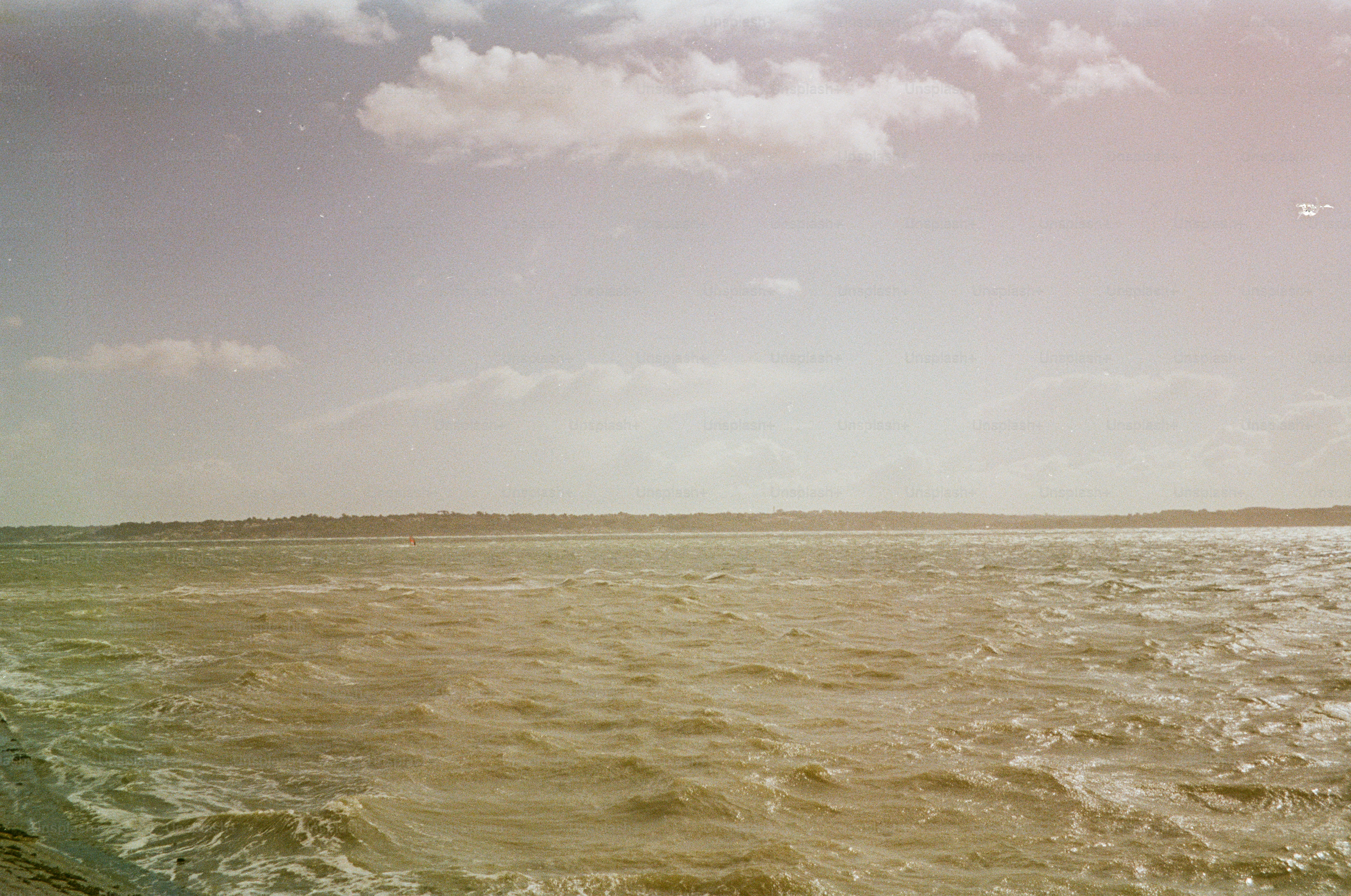Rough sea waves crash against a concrete barrier photo – Film ...