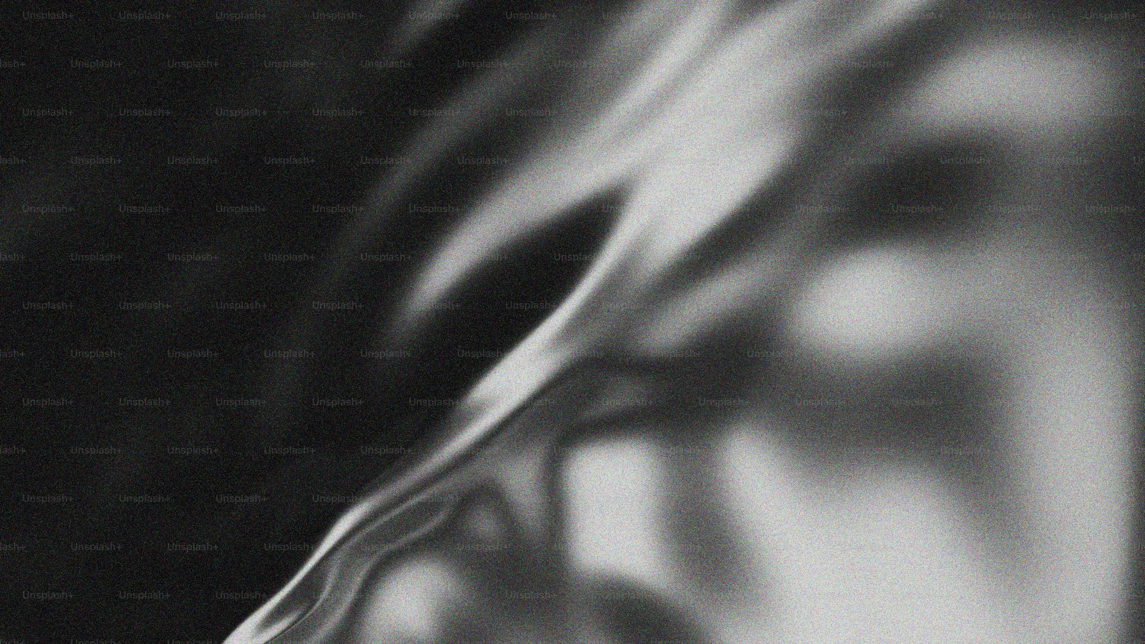 Abstract swirling metallic fabric with light reflections. photo ...