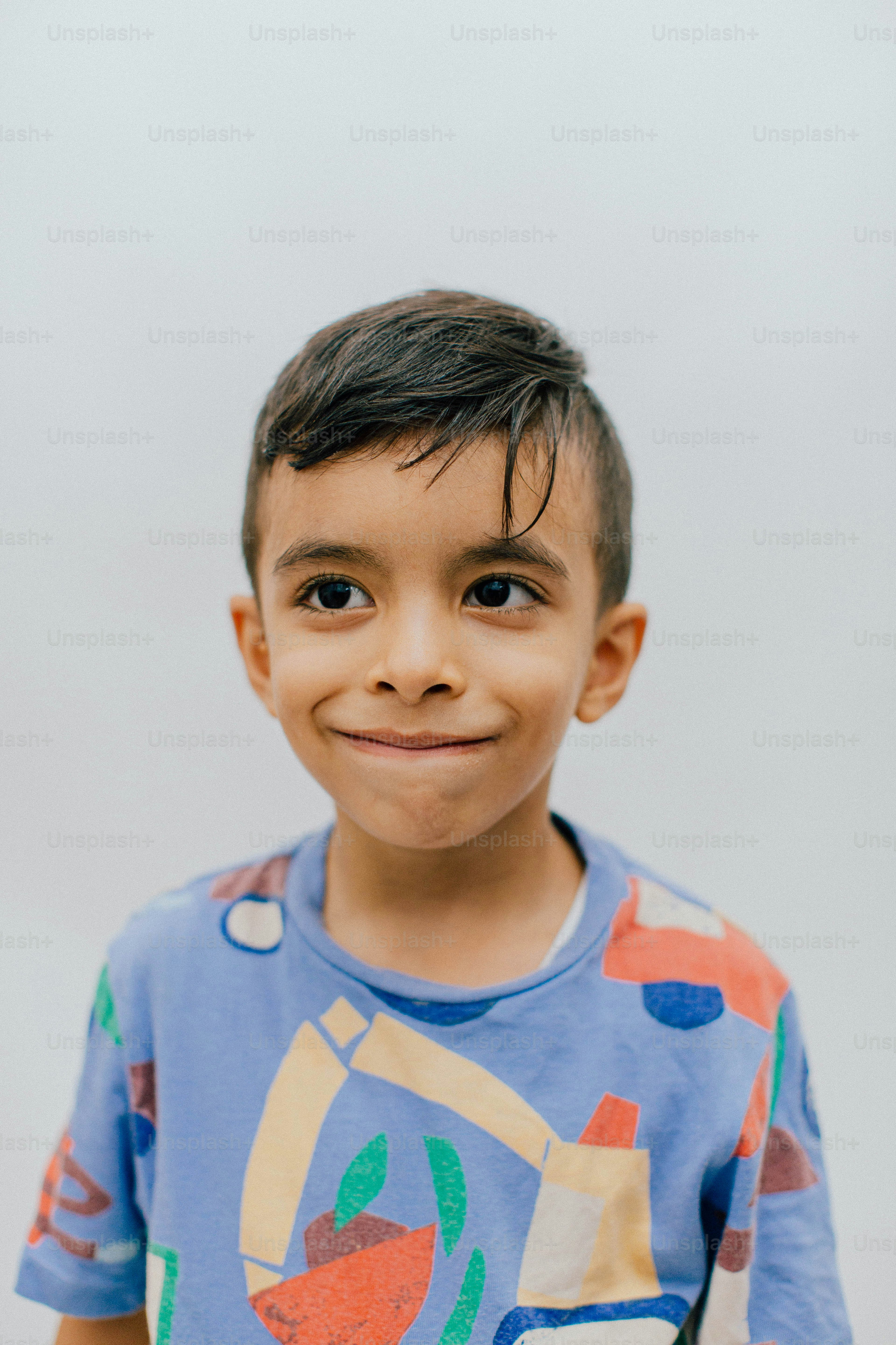 Young boy with dark hair and a blue shirt photo – Happy Image on Unsplash