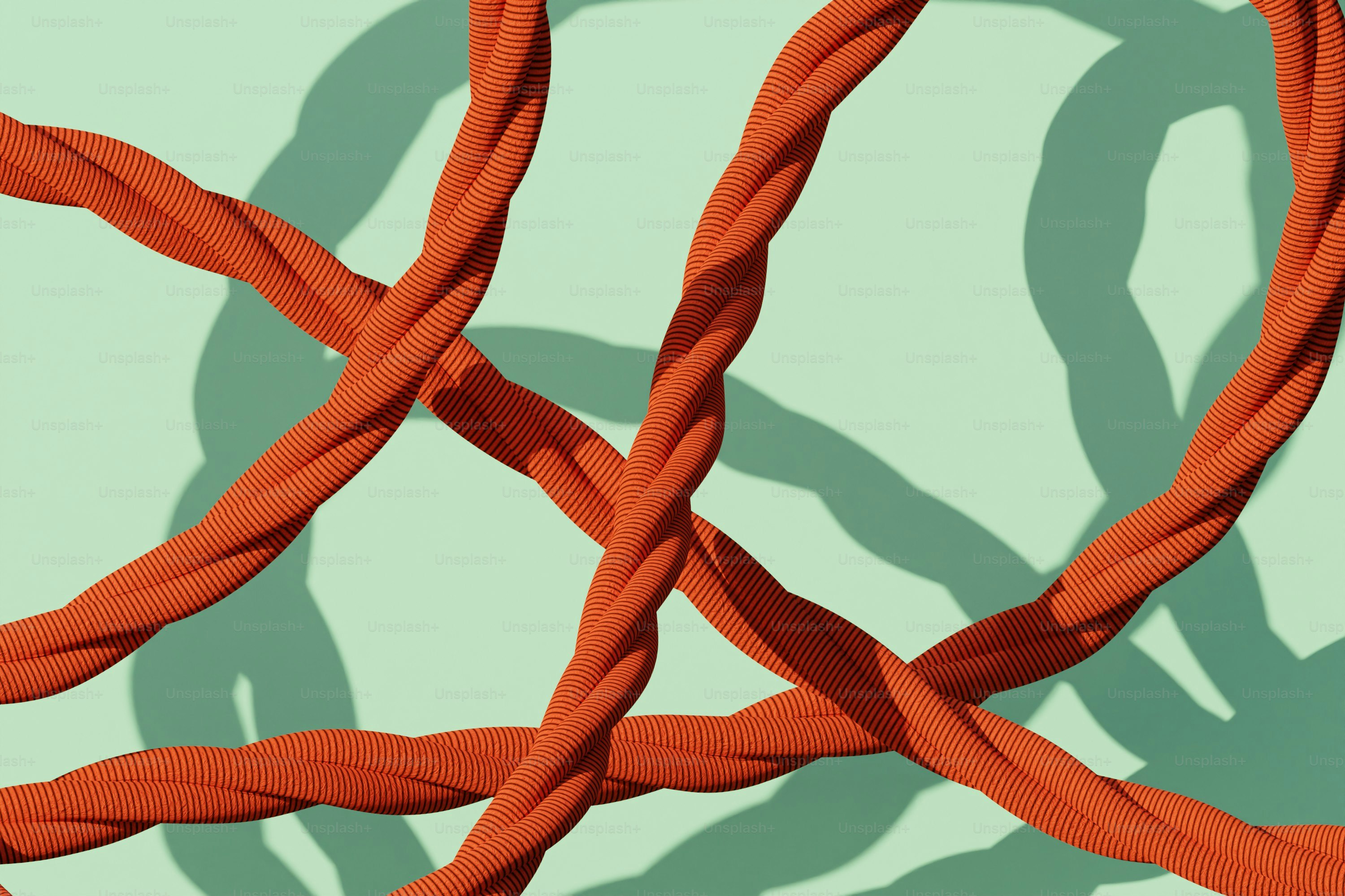 Orange twisted ropes on a light green background photo – 3d render ...