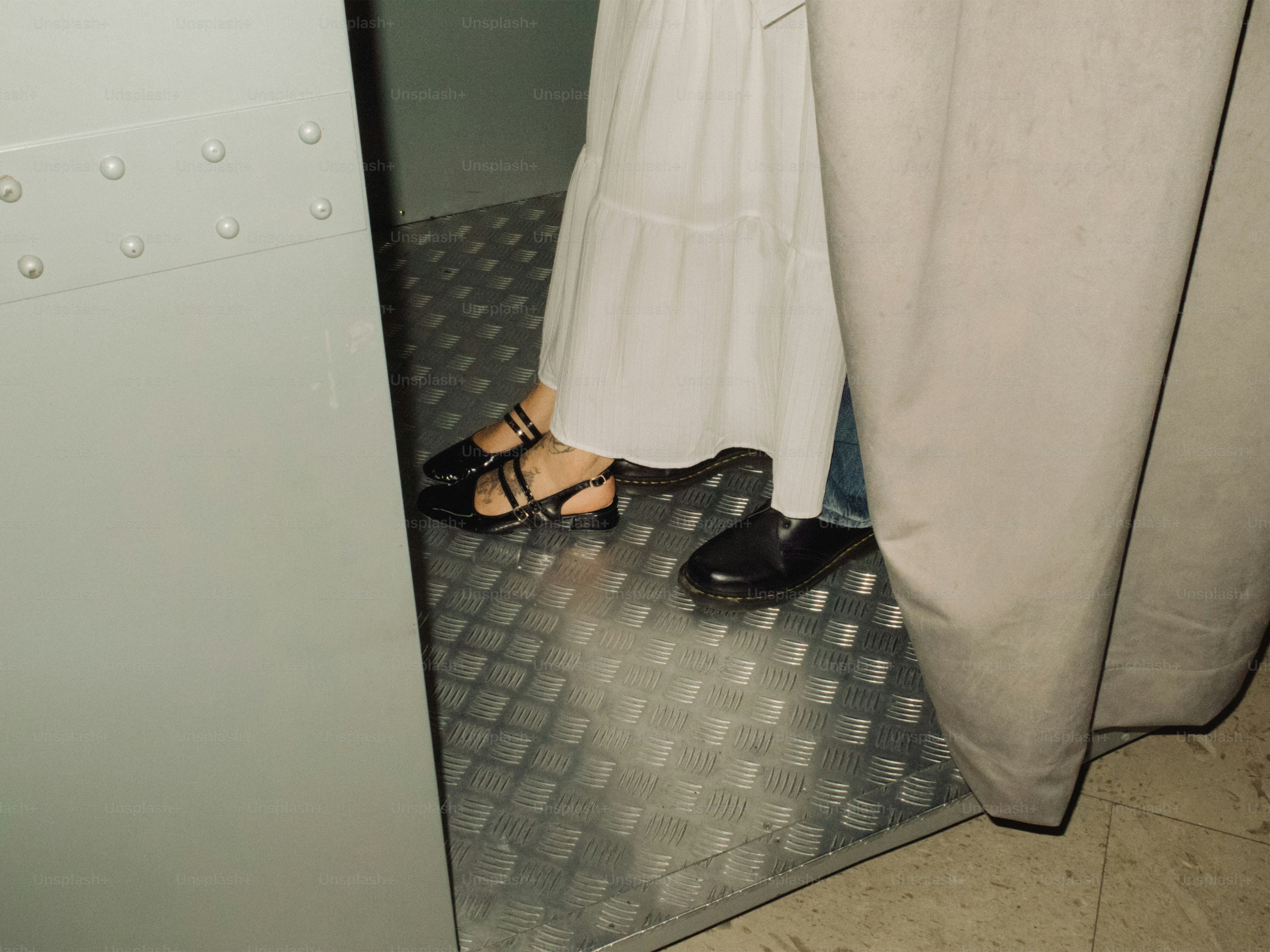 Two people stand close together in a confined space. photo – Photo ...